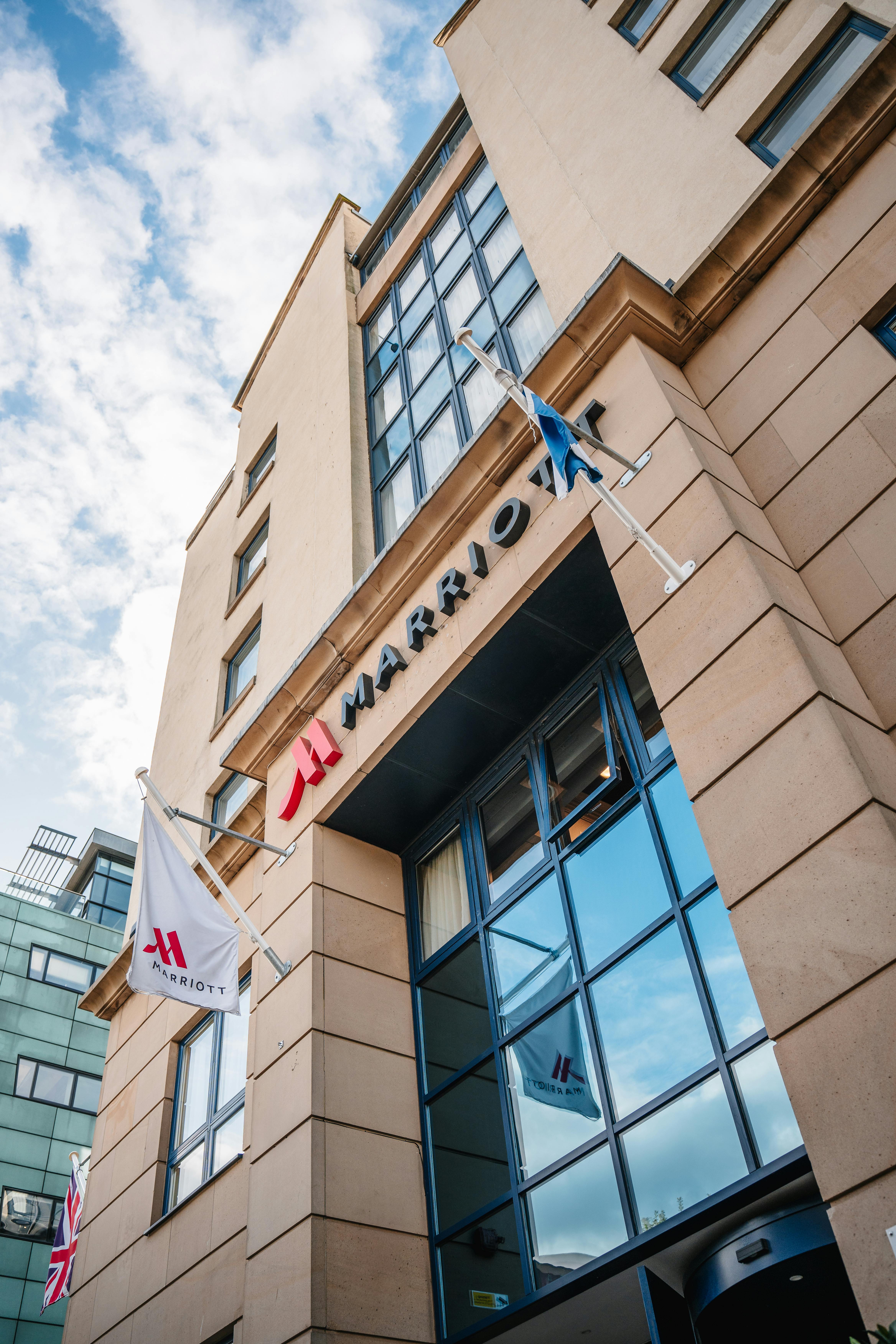 Modern Marriott Hotel Facade with Flags · Free Stock Photo