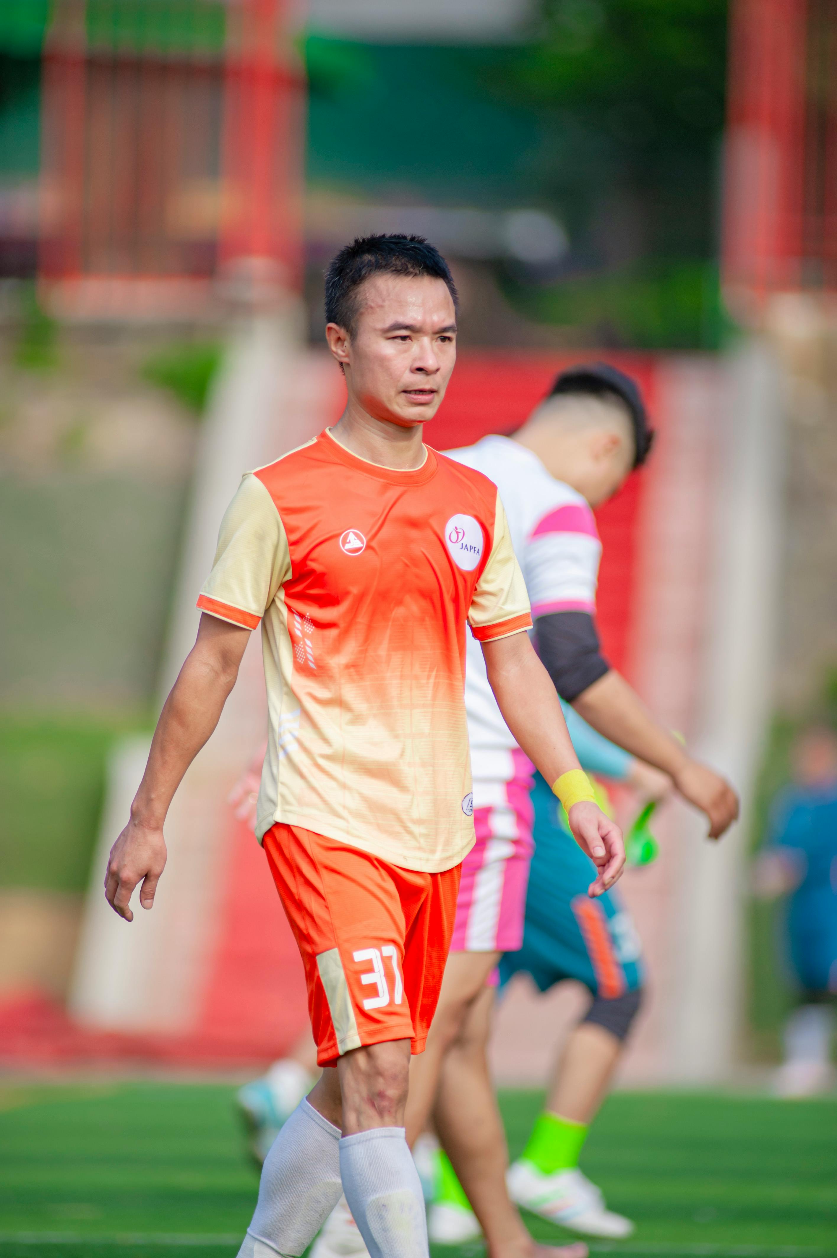 Soccer Player in Action on Hanoi Field · Free Stock Photo