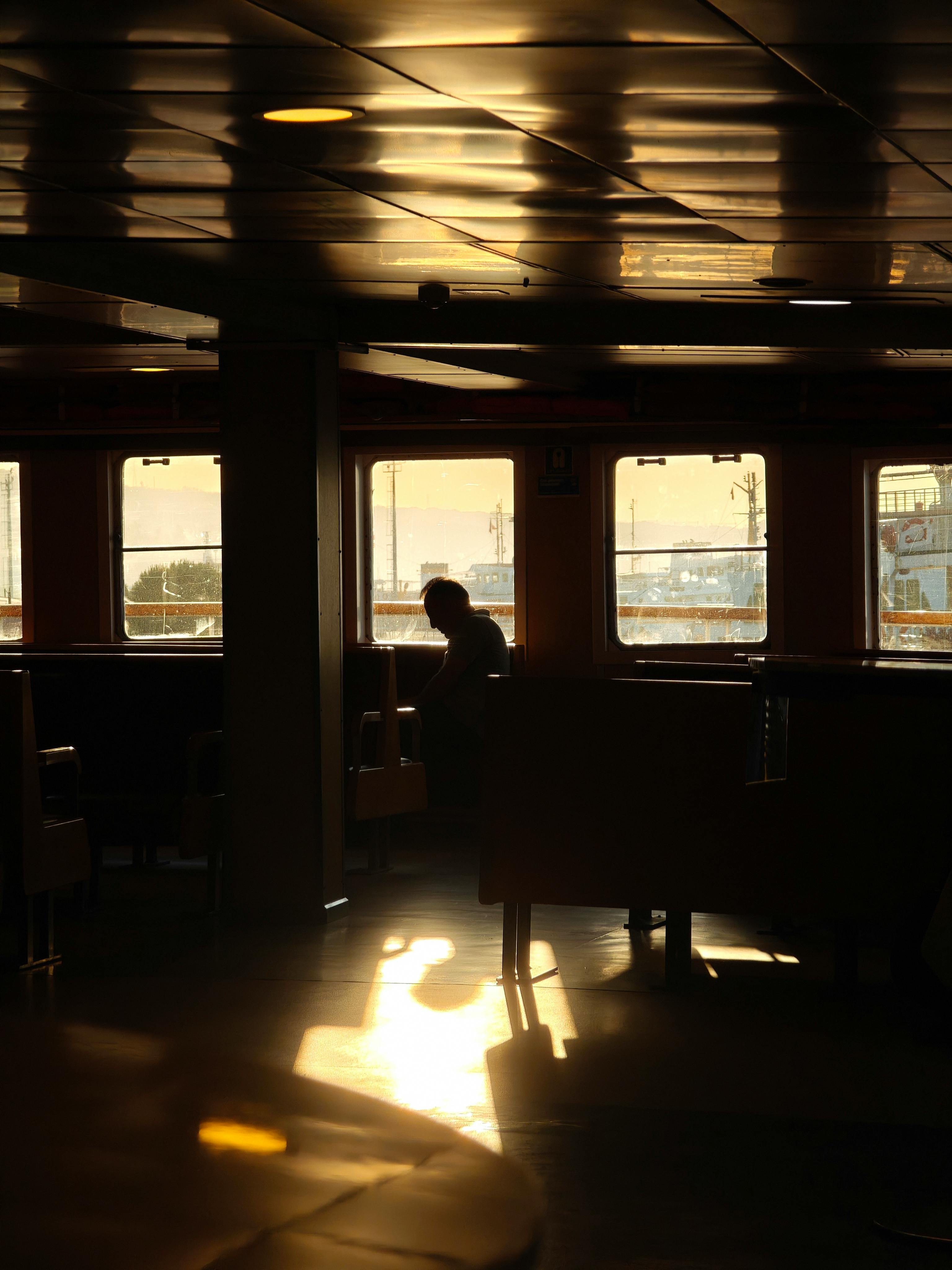 Golden Sunset Silhouette Inside a Ferry · Free Stock Photo