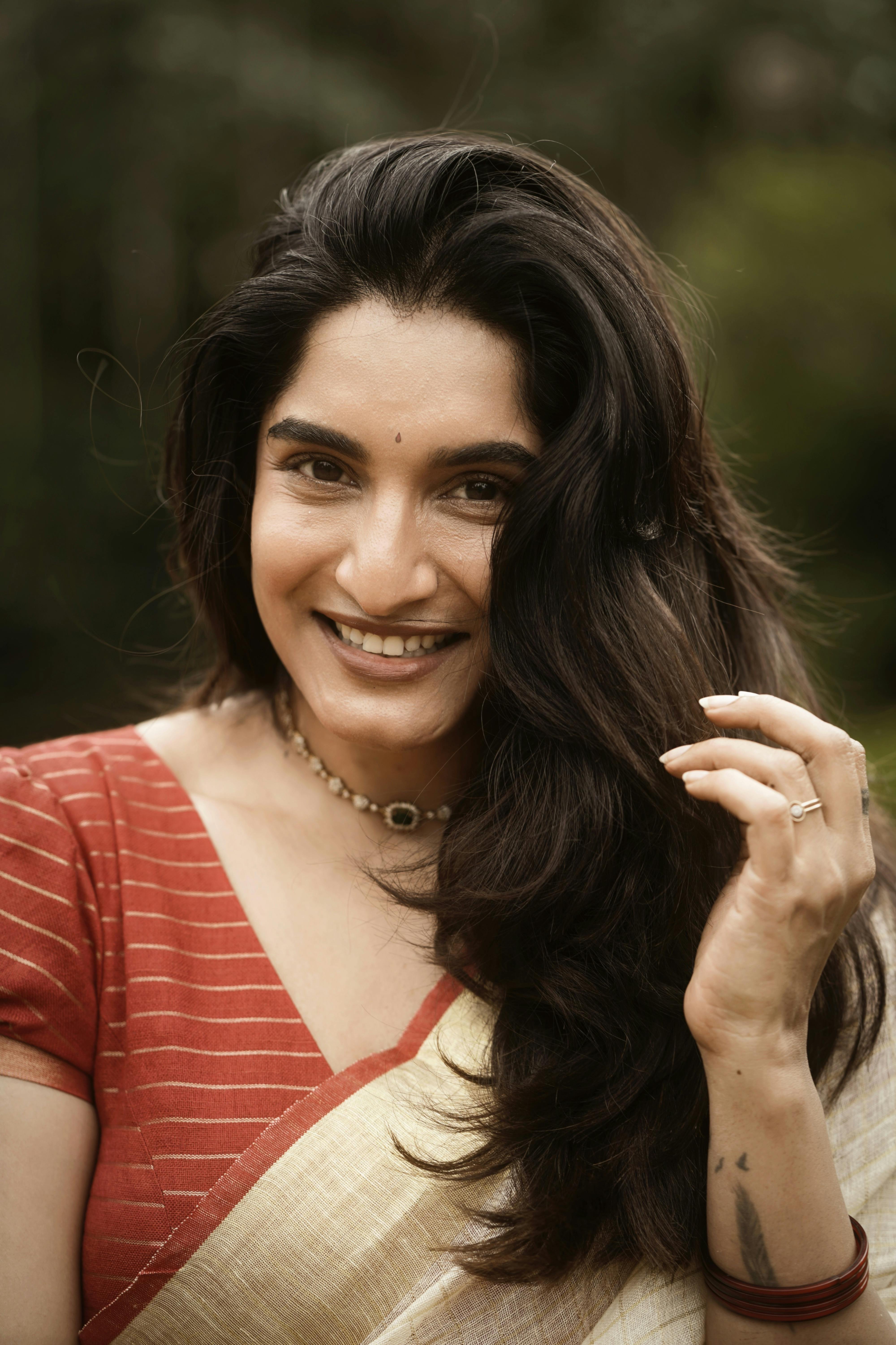 Portrait of a Smiling Woman in Traditional Attire · Free Stock Photo
