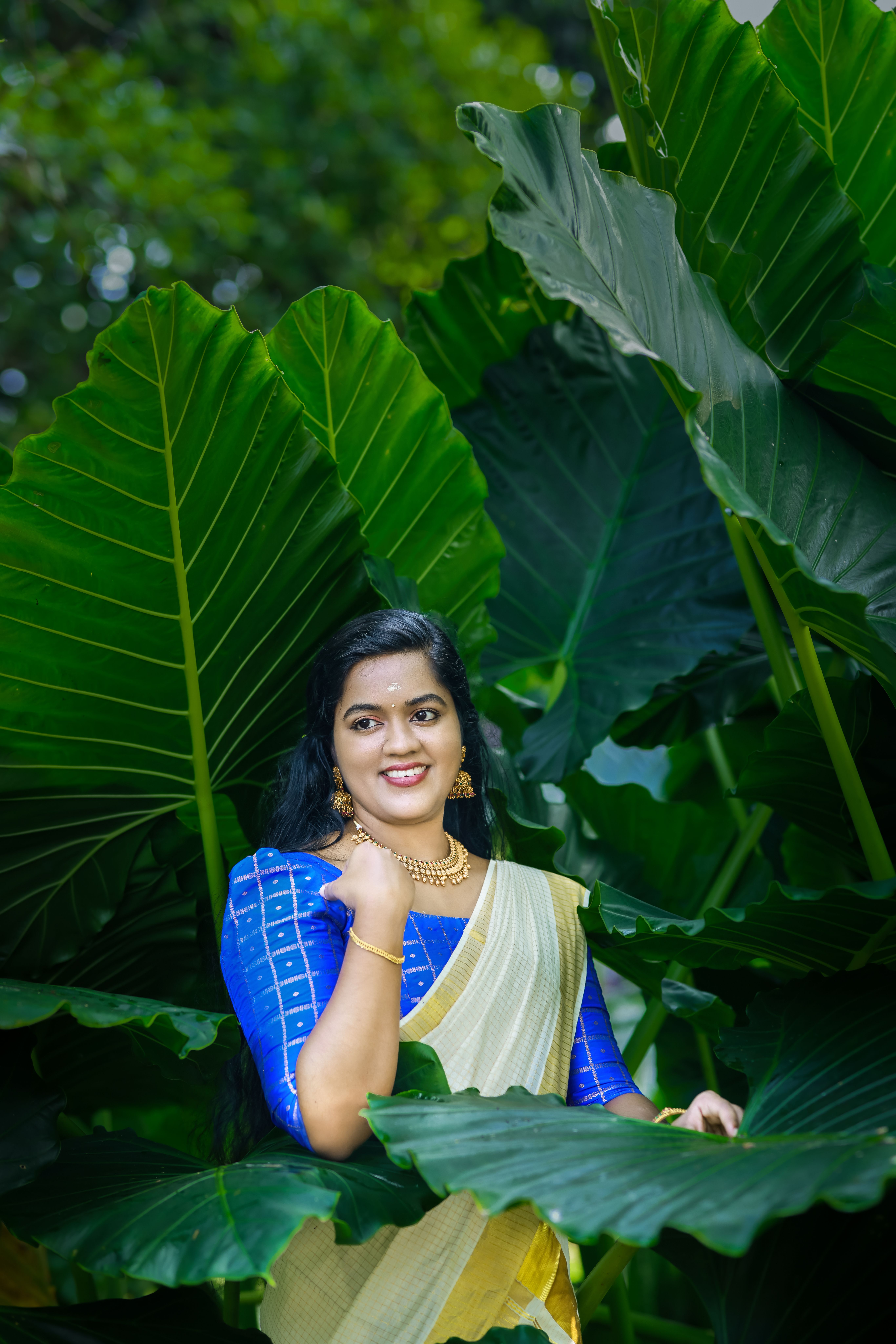 Woman in Traditional Indian Attire Amidst Lush Foliage · Free Stock Photo