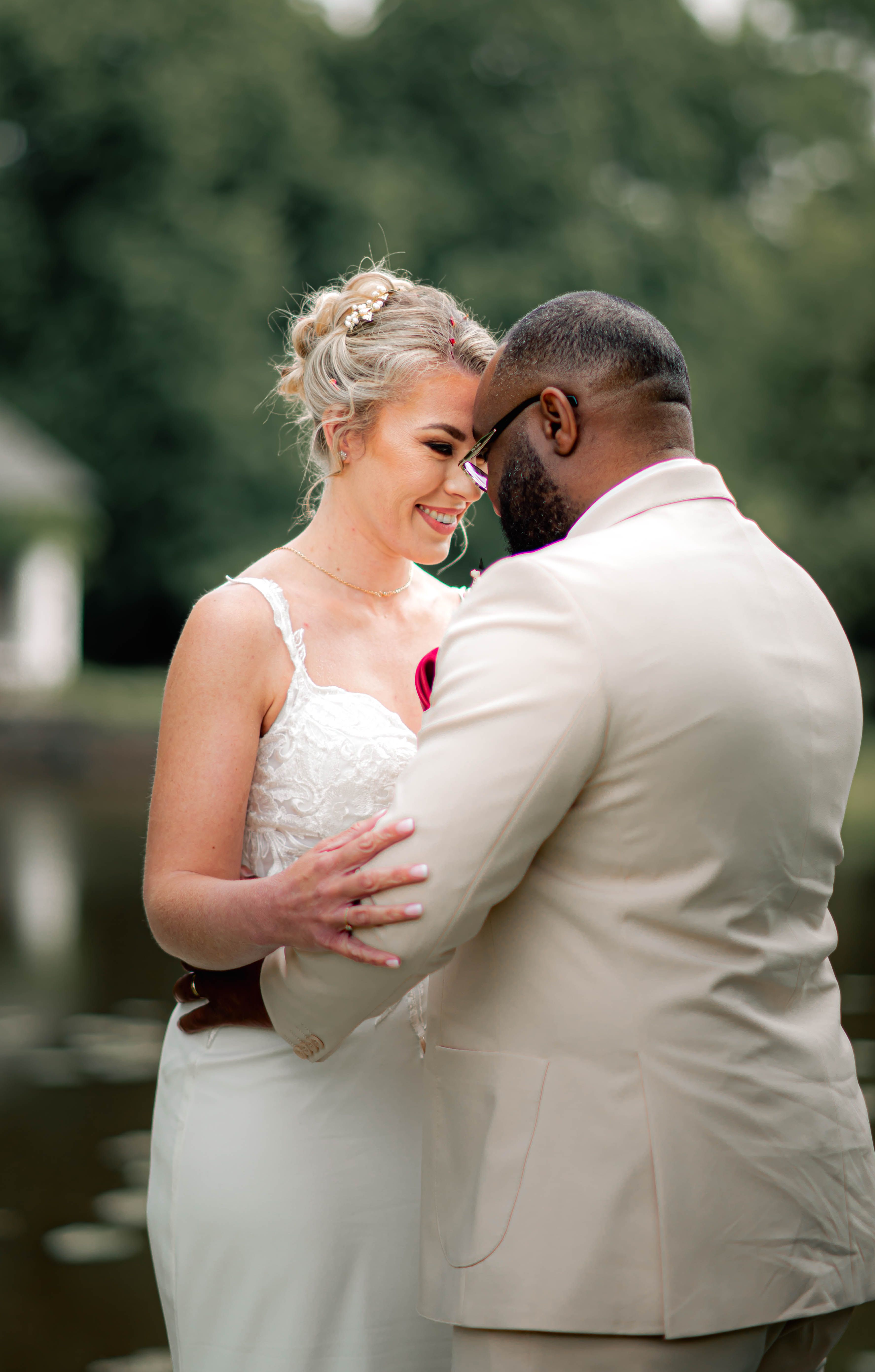 Romantic Wedding Couple Embracing Outdoors · Free Stock Photo