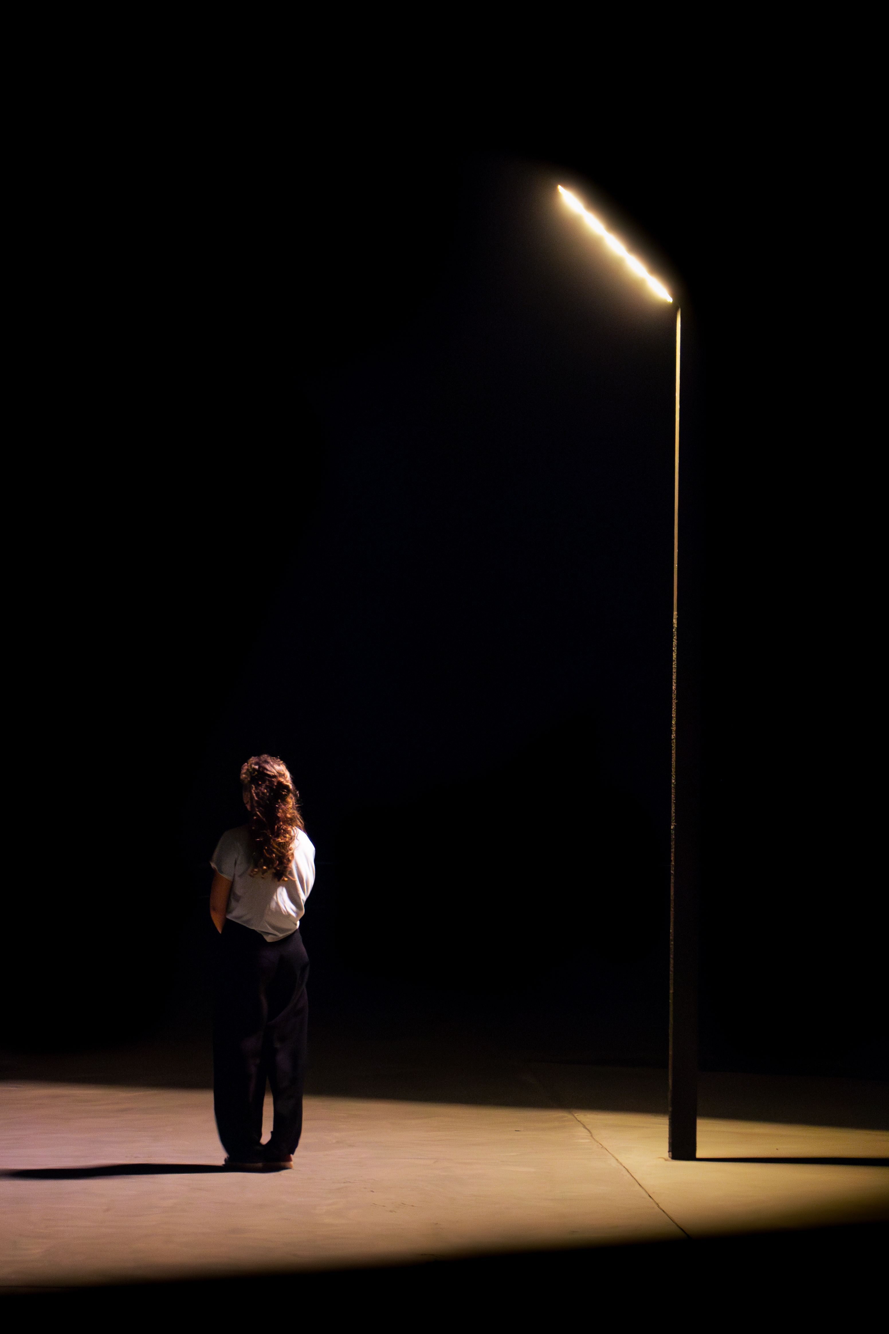 Solitary Figure Under a Streetlight at Night · Free Stock Photo