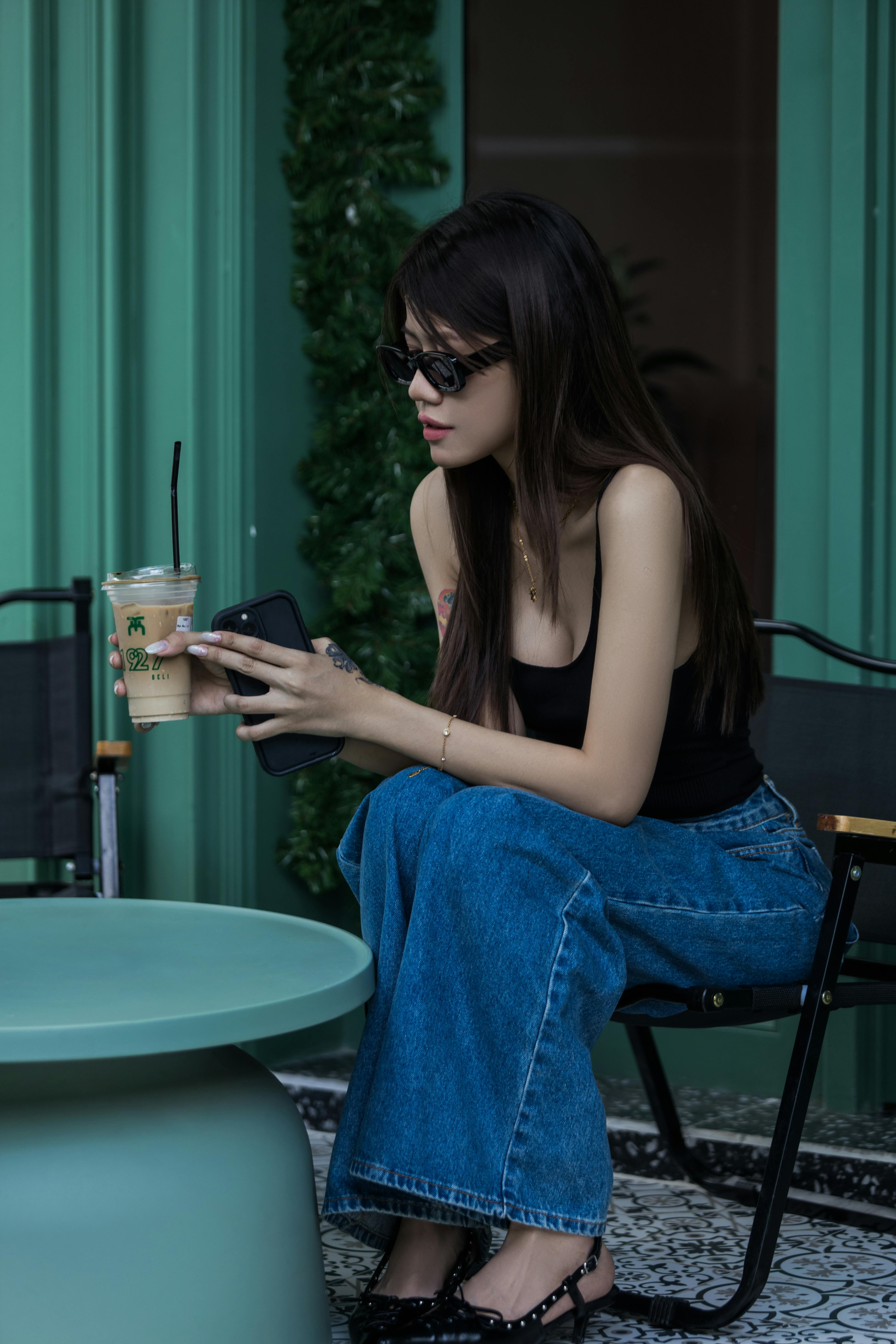 Stylish Woman Relaxing with Iced Coffee Outdoors · Free Stock Photo