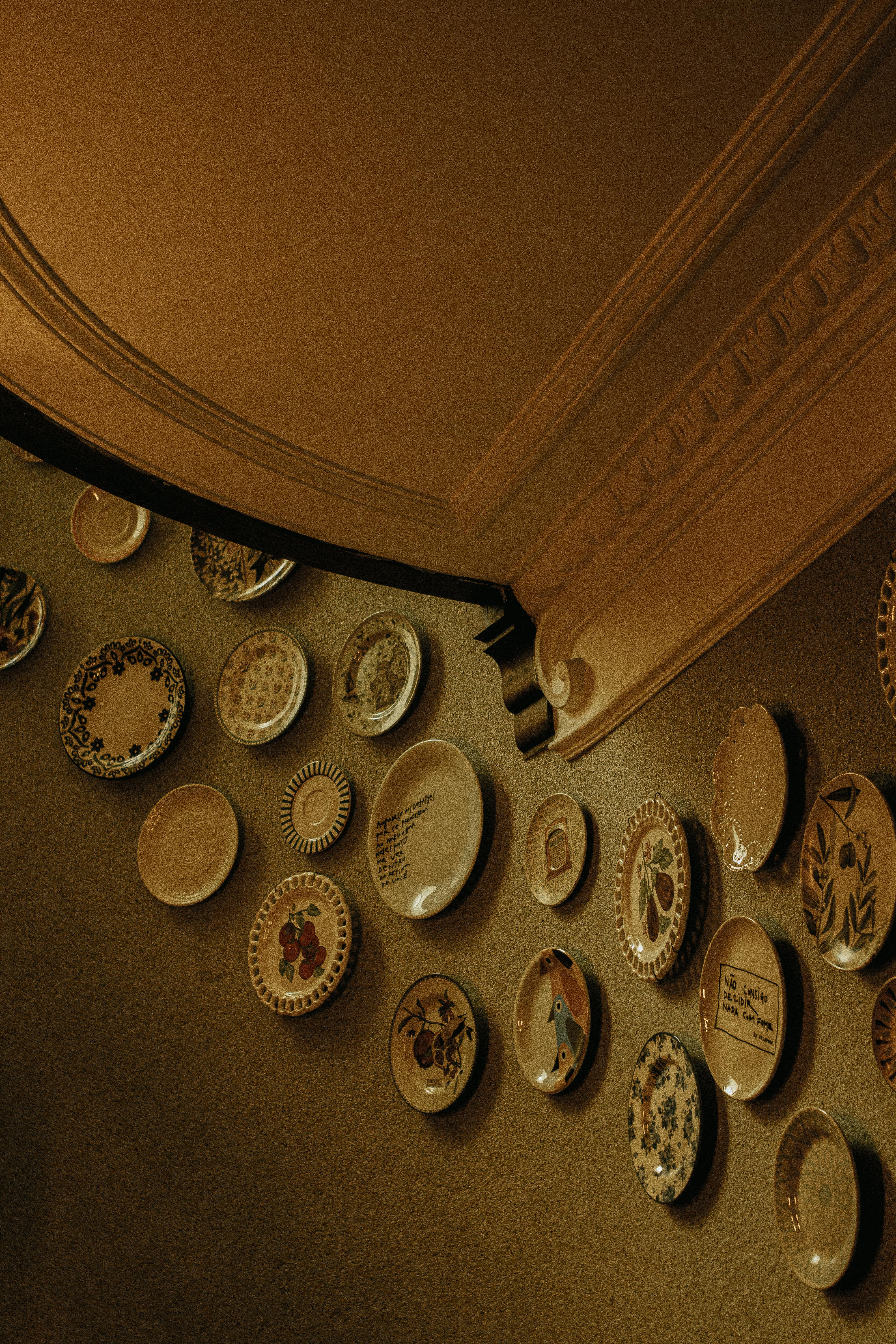 Artistic Display of Decorative Plates on Wall · Free Stock Photo