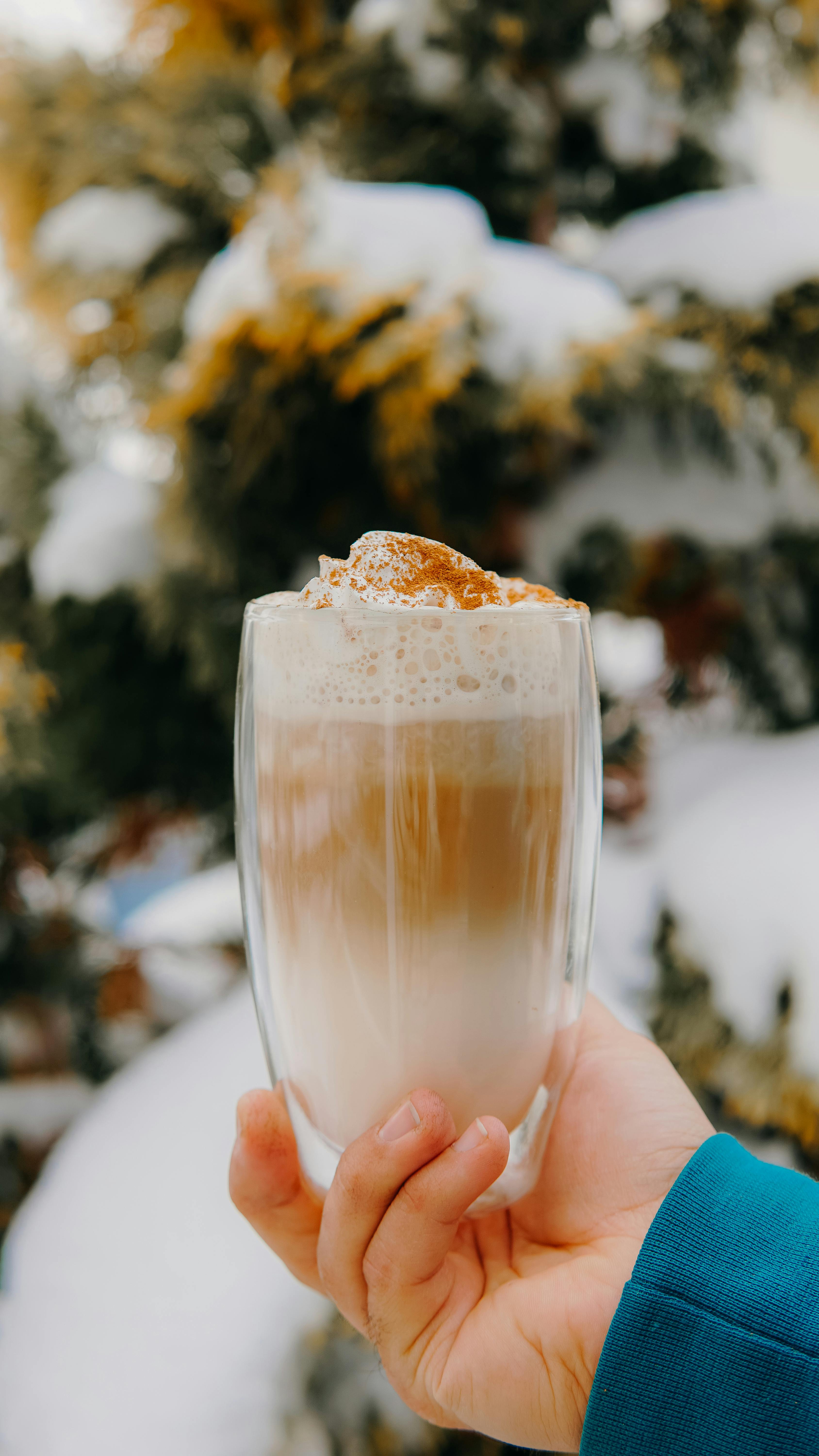 Cozy Winter Latte Held Outdoors in Snowy Scene · Free Stock Photo