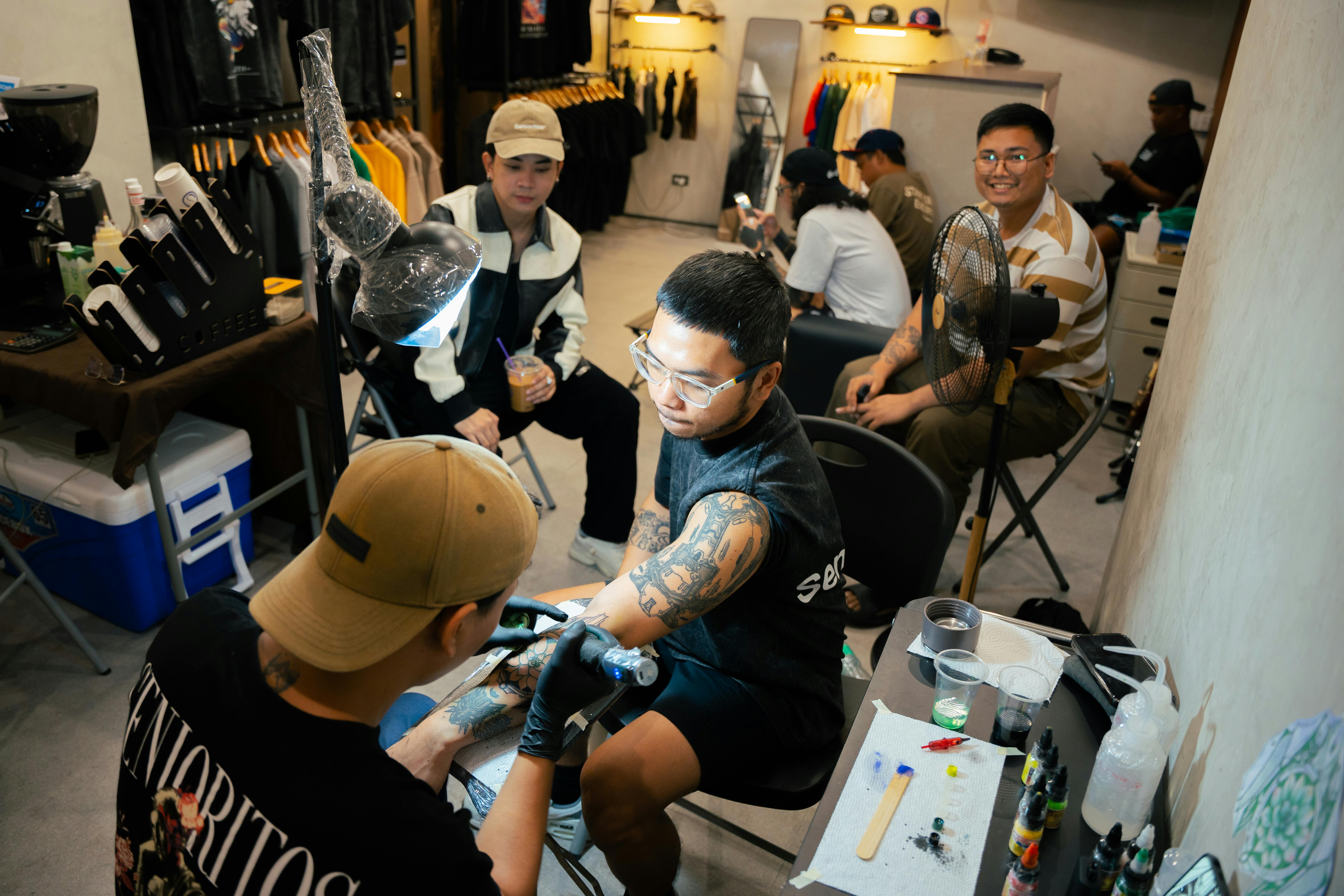 Tattoo Artist at Work in Studio Environment · Free Stock Photo