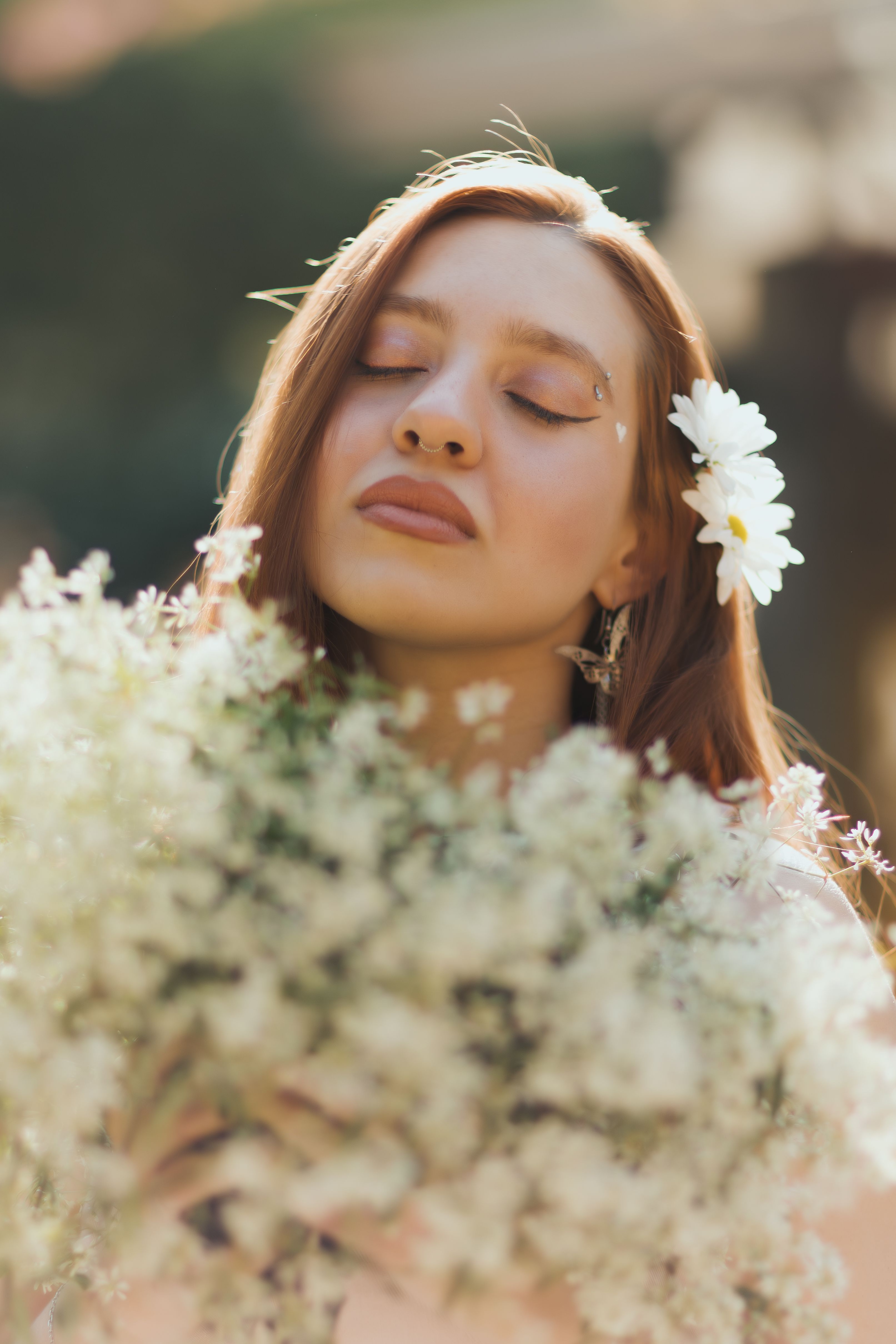 Woman Embracing Nature with Floral Bouquet Outdoors · Free Stock Photo