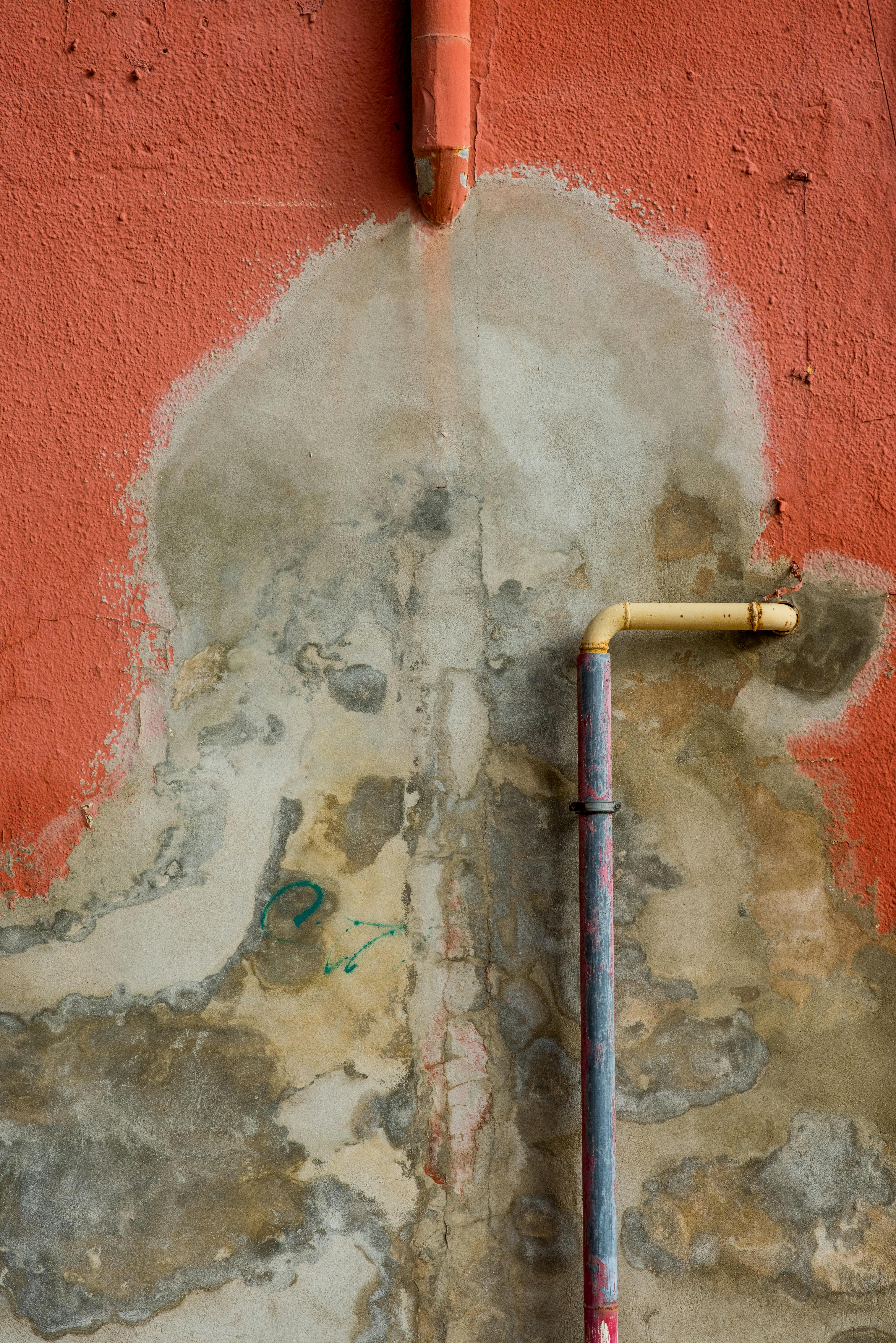 Aged Wall with Exposed Pipe and Water Stains · Free Stock Photo