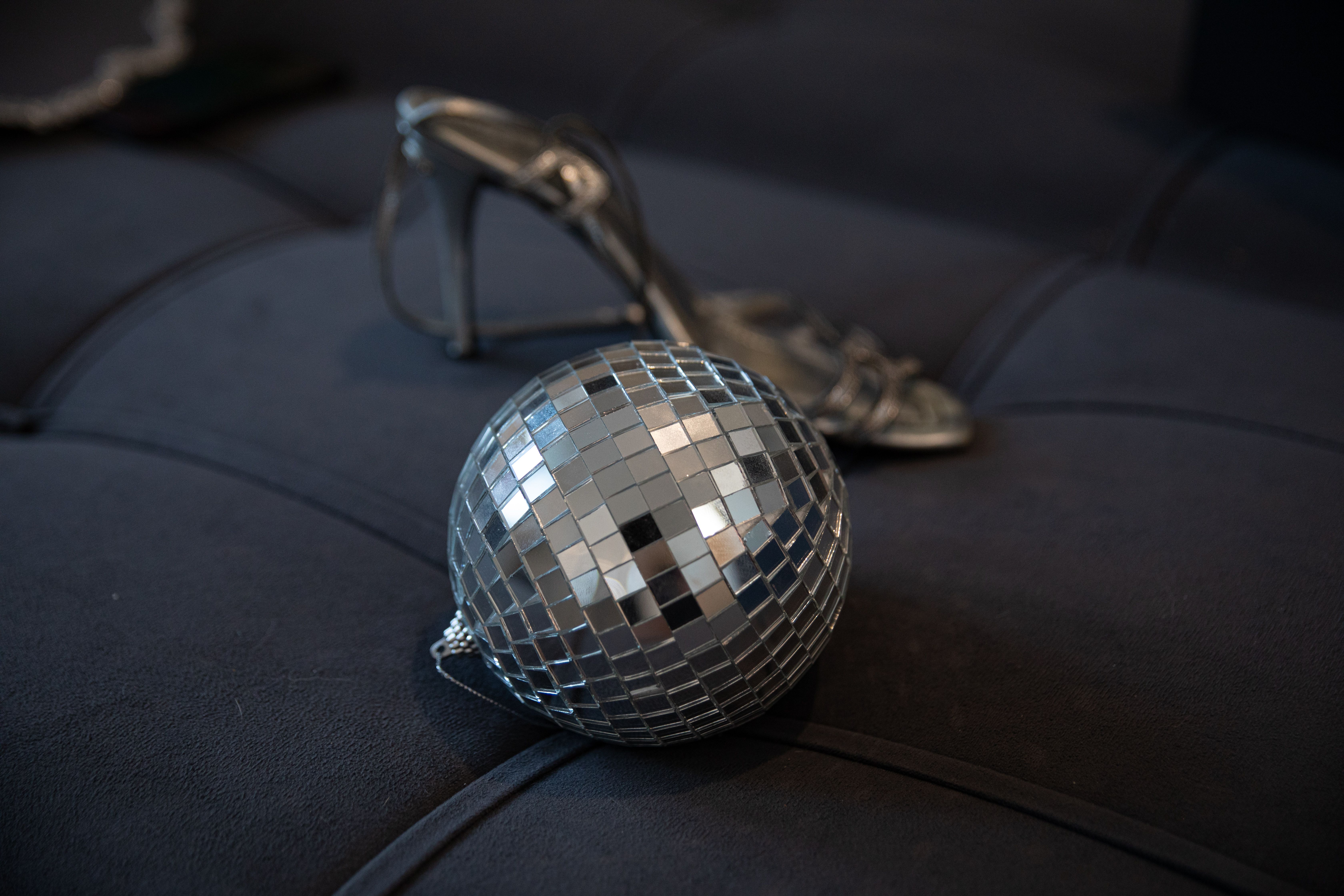 Elegant Silver Disco Ball on Dark Sofa · Free Stock Photo