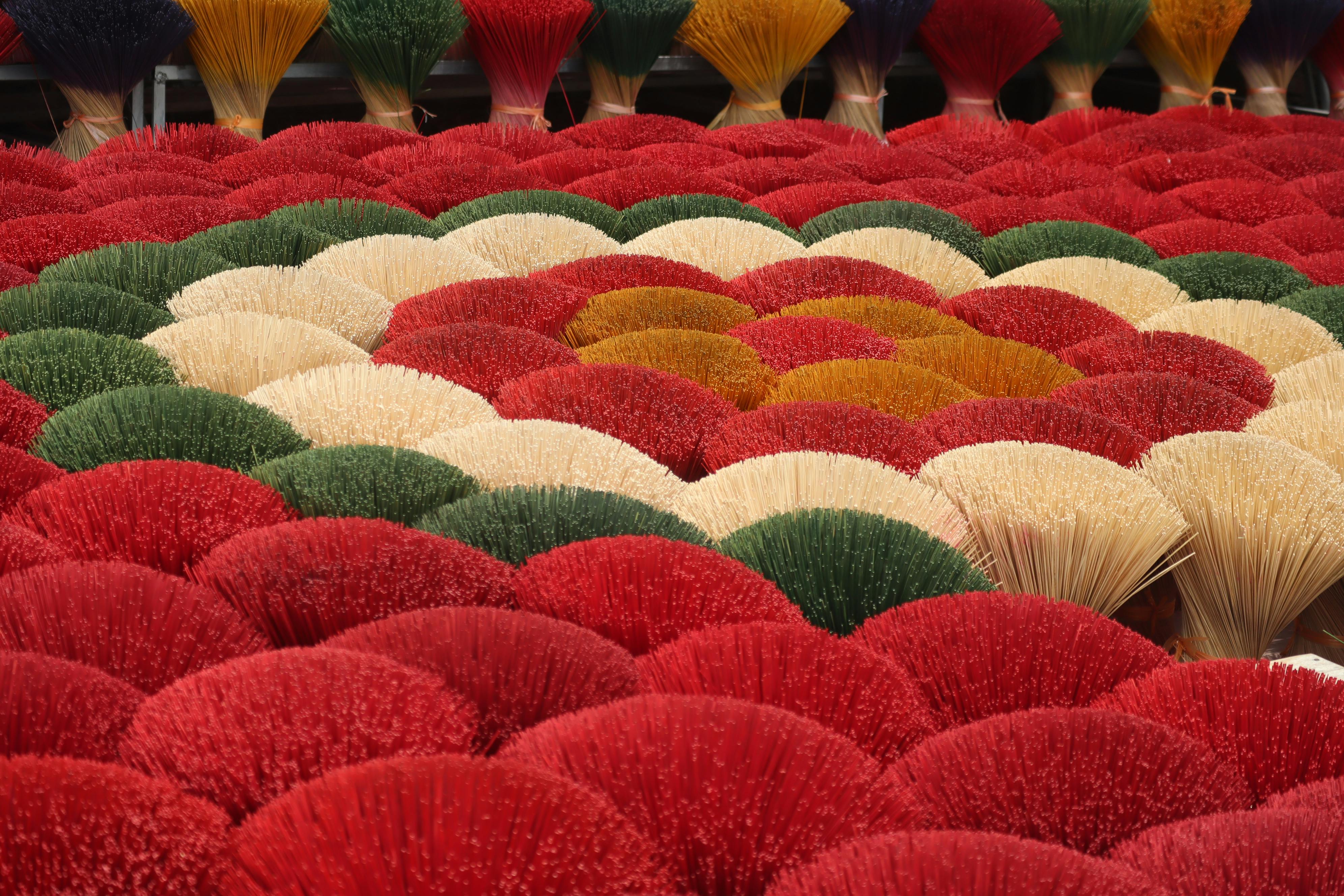 Colorful incense sticks arranged in geometric pattern · Free Stock Photo