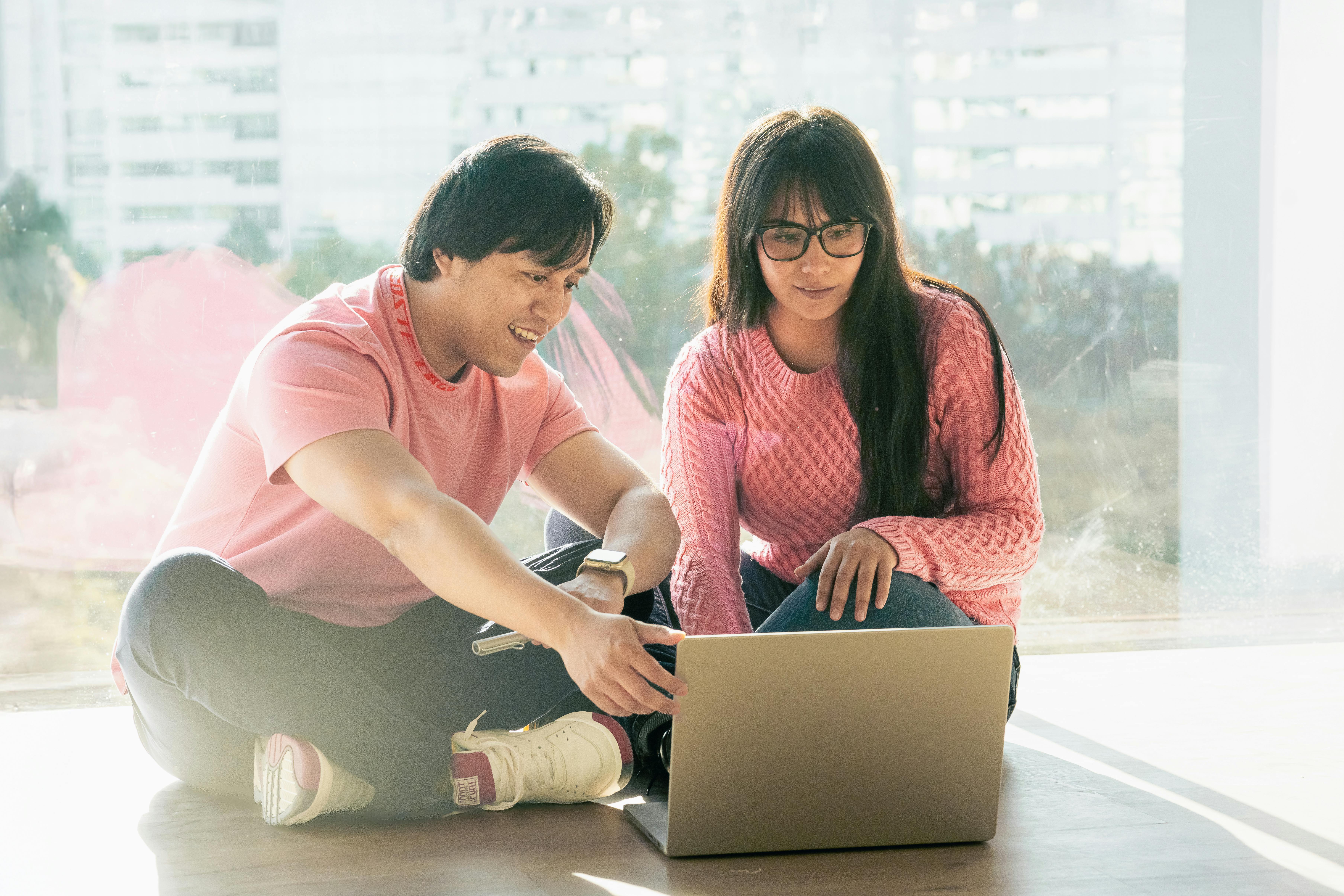 Young Couple Collaborating on Laptop Indoors · Free Stock Photo