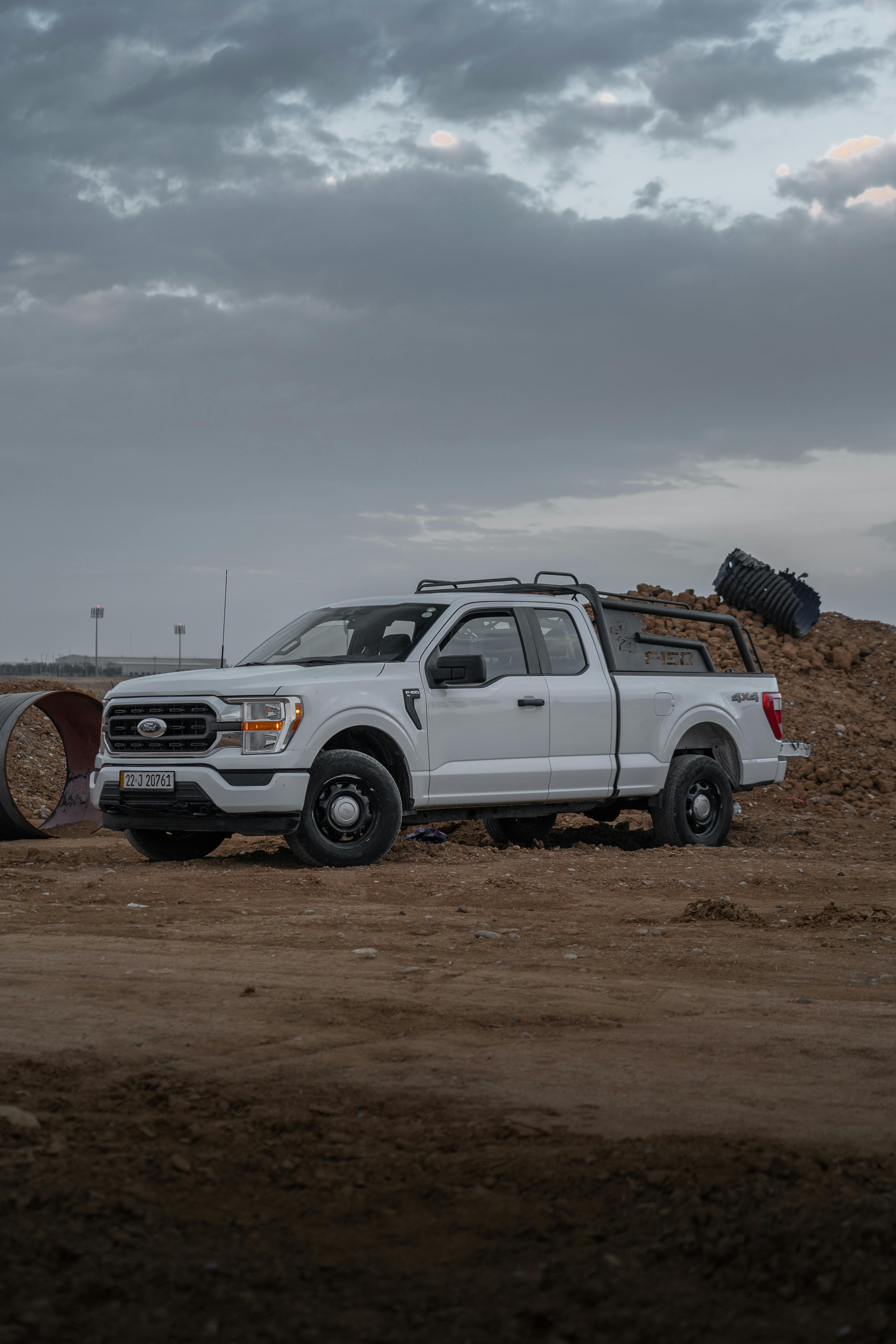 White Pickup Truck in Off-Road Construction Site · Free Stock Photo