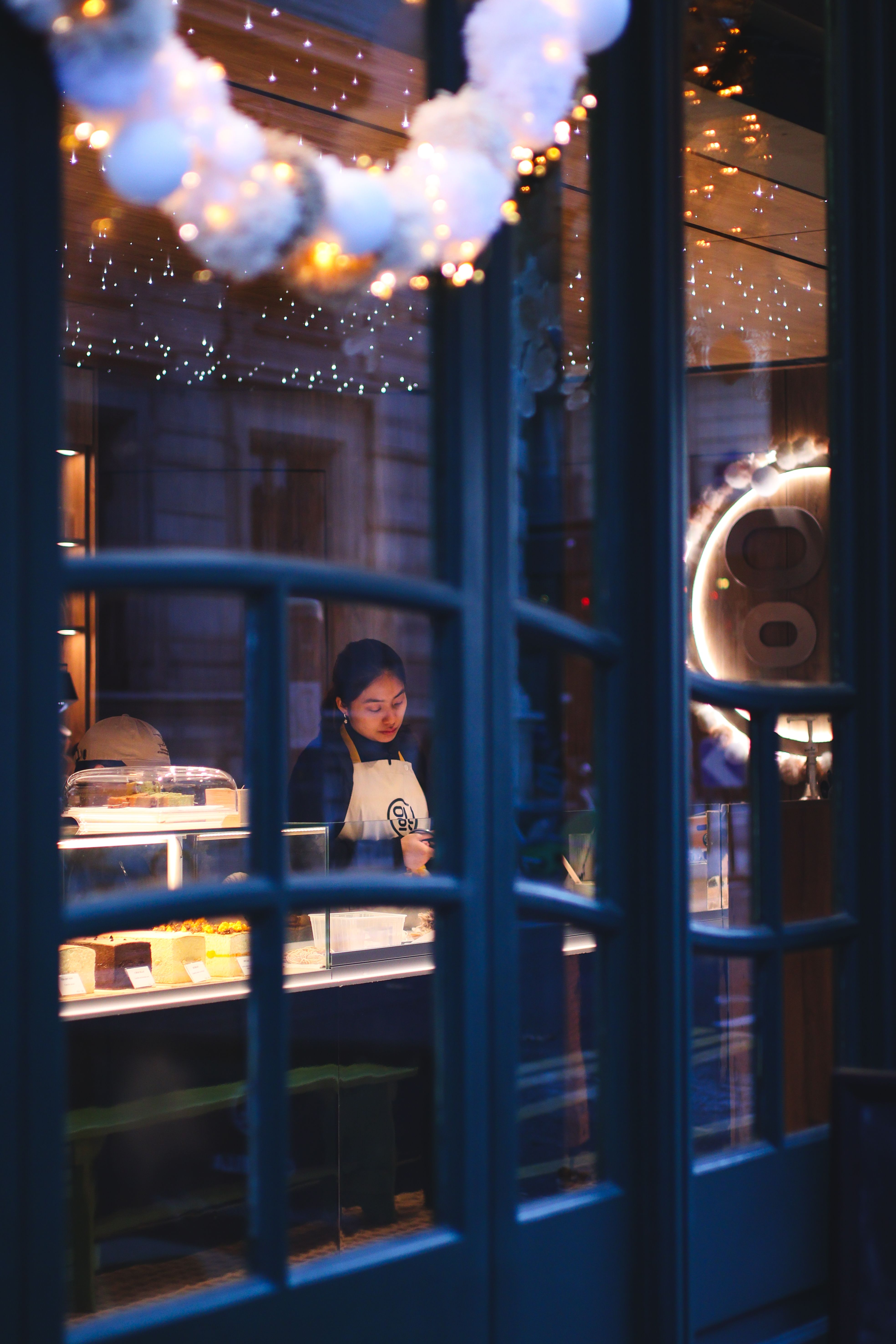 Cozy Cafe Scene Through Window at Nighttime · Free Stock Photo