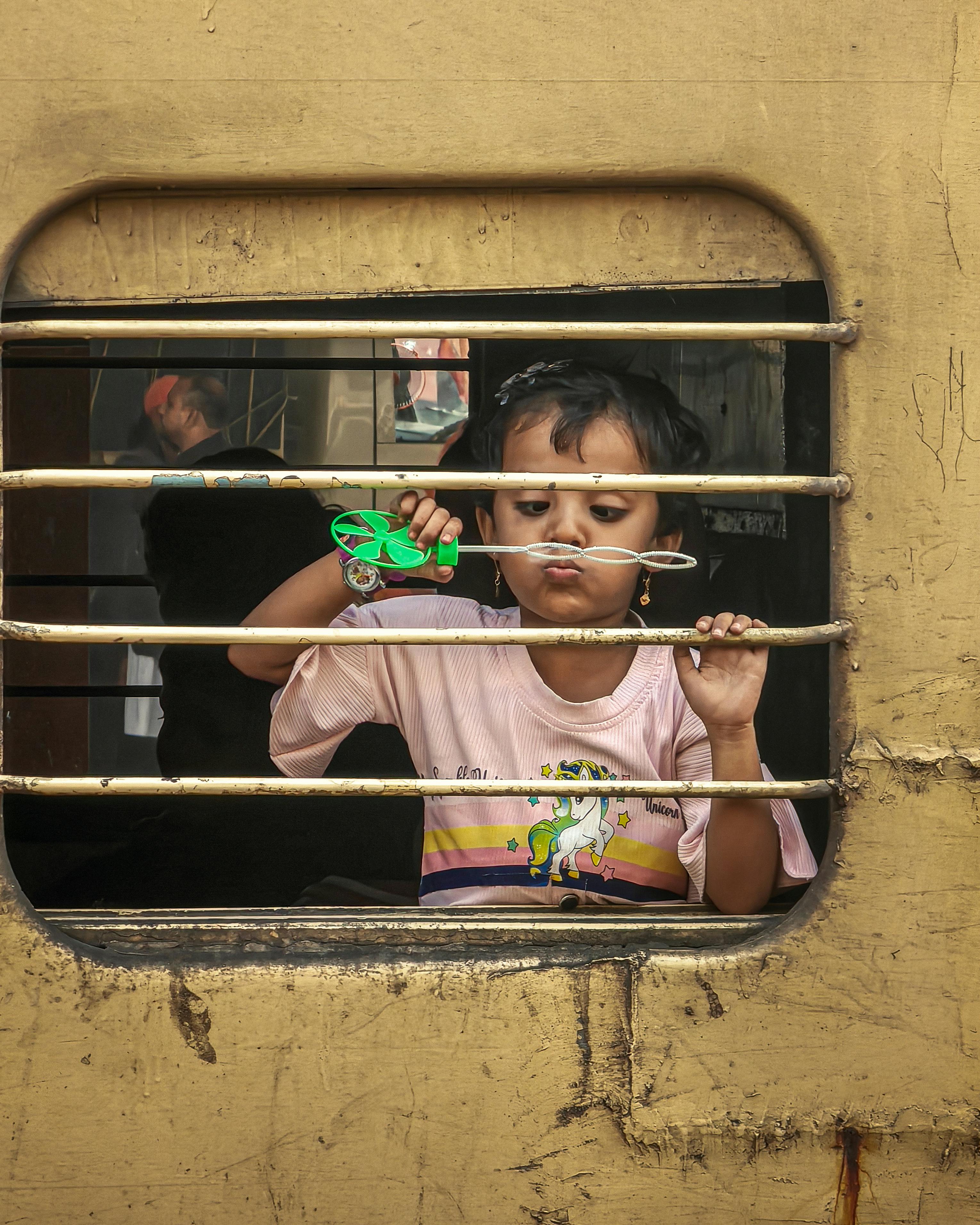 Child Looking out of a Train Window · Free Stock Photo