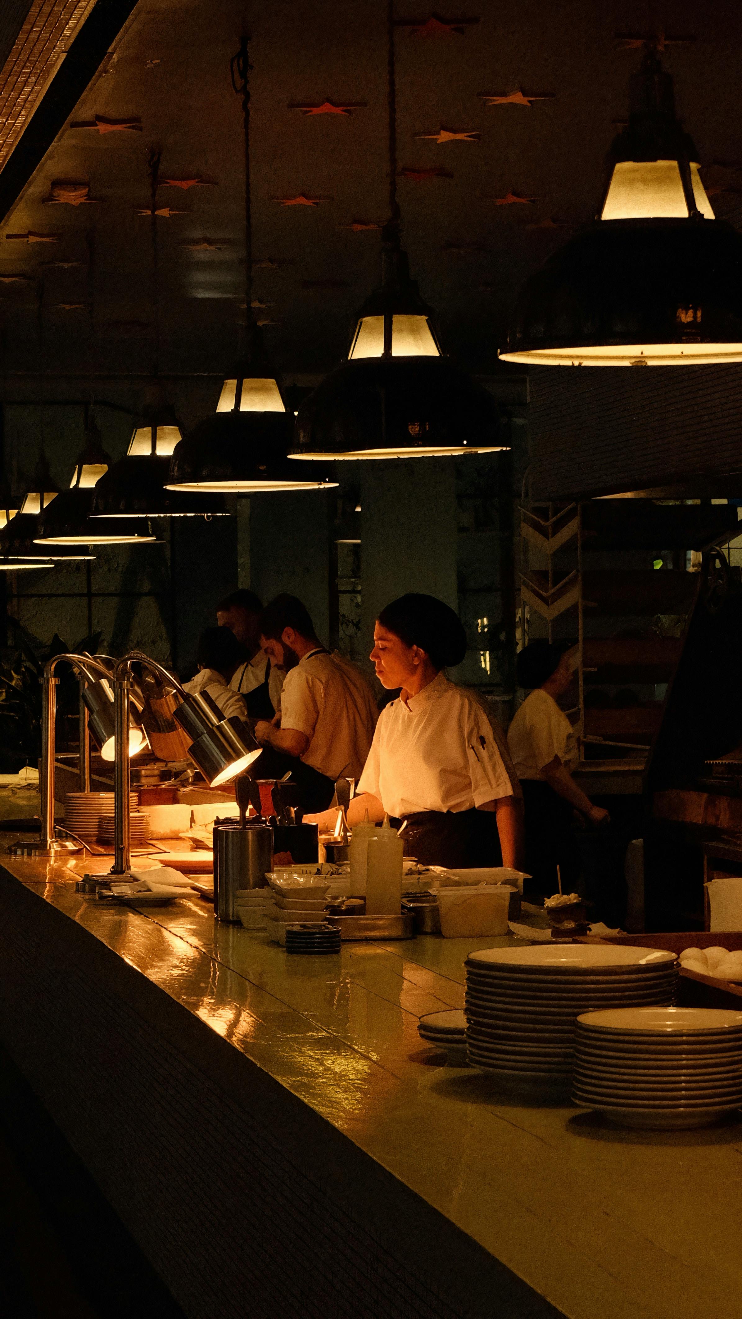 Culinary Team in Open Kitchen at Night · Free Stock Photo