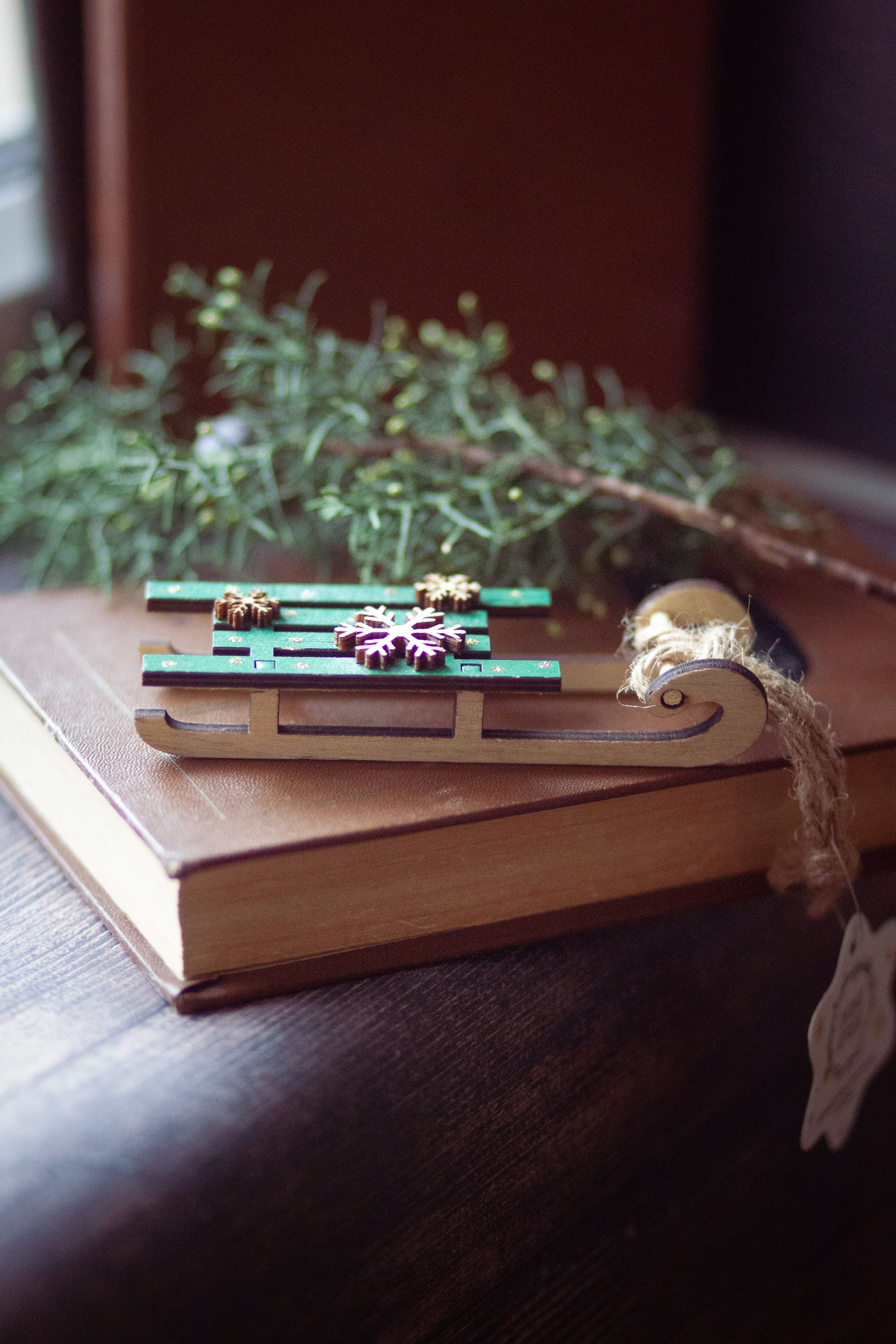 Vintage Wooden Sled on Rustic Book · Free Stock Photo