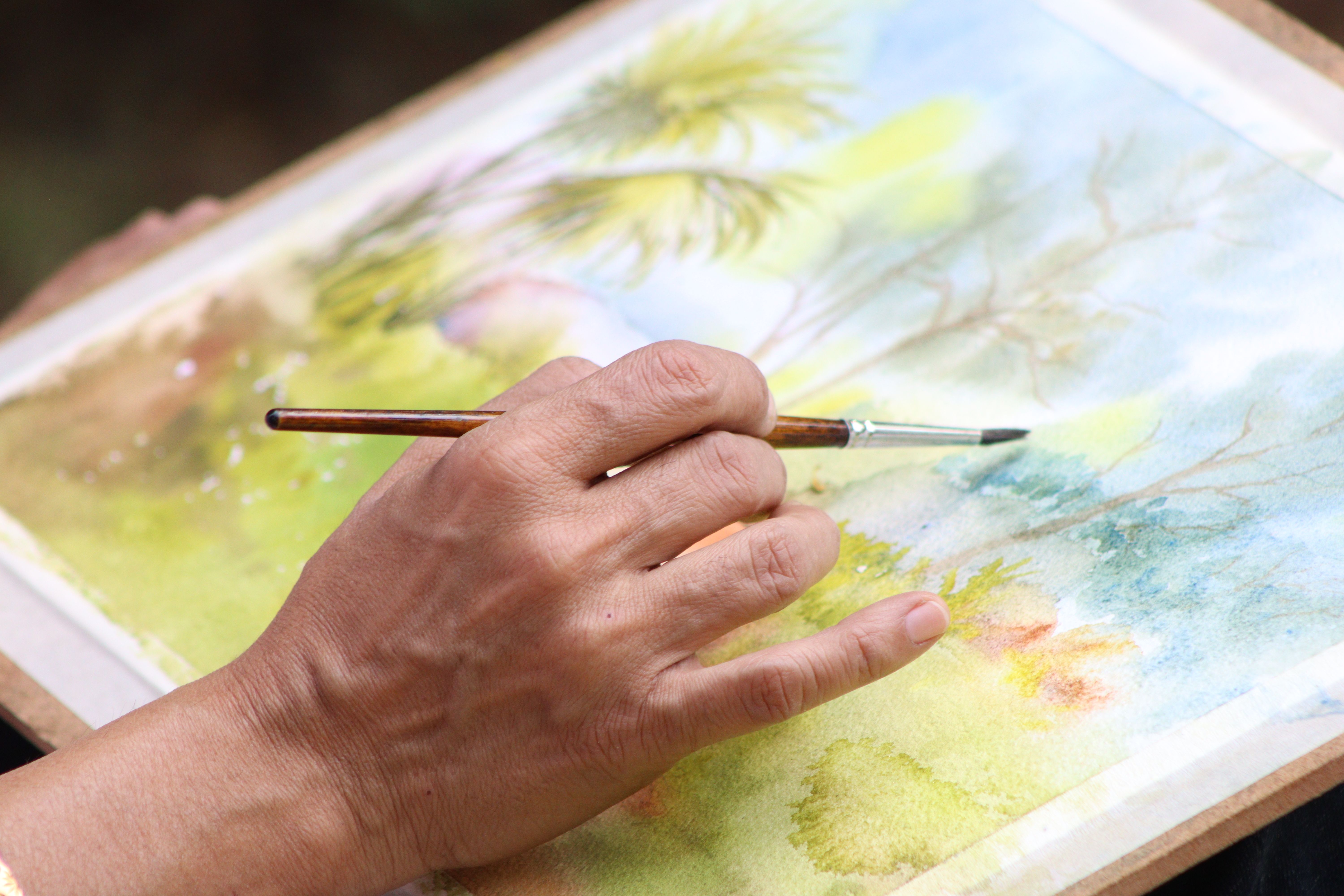 Close-Up of Hand Painting a Watercolor Landscape · Free Stock Photo