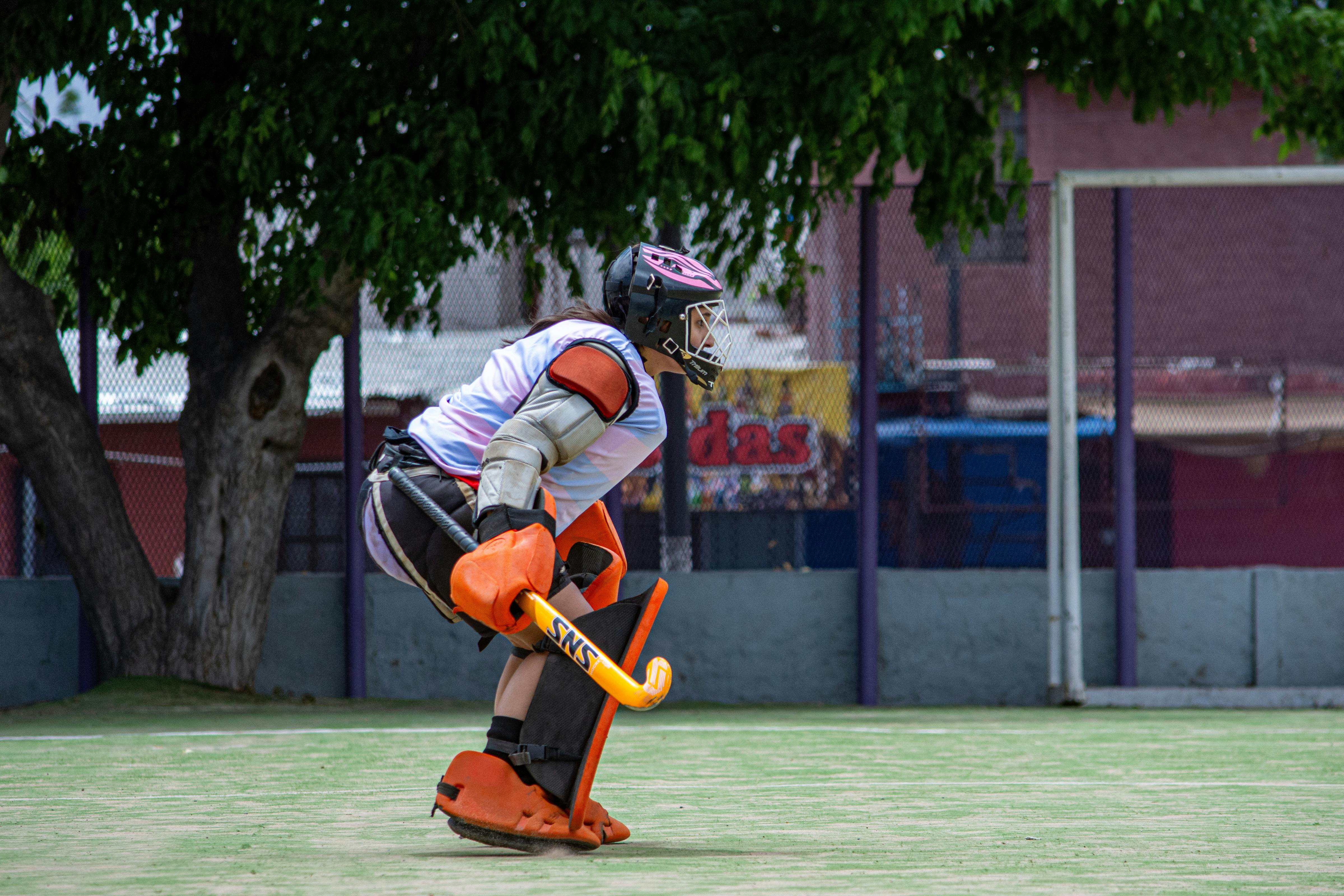 Field Hockey Goalie in Action Outdoors · Free Stock Photo