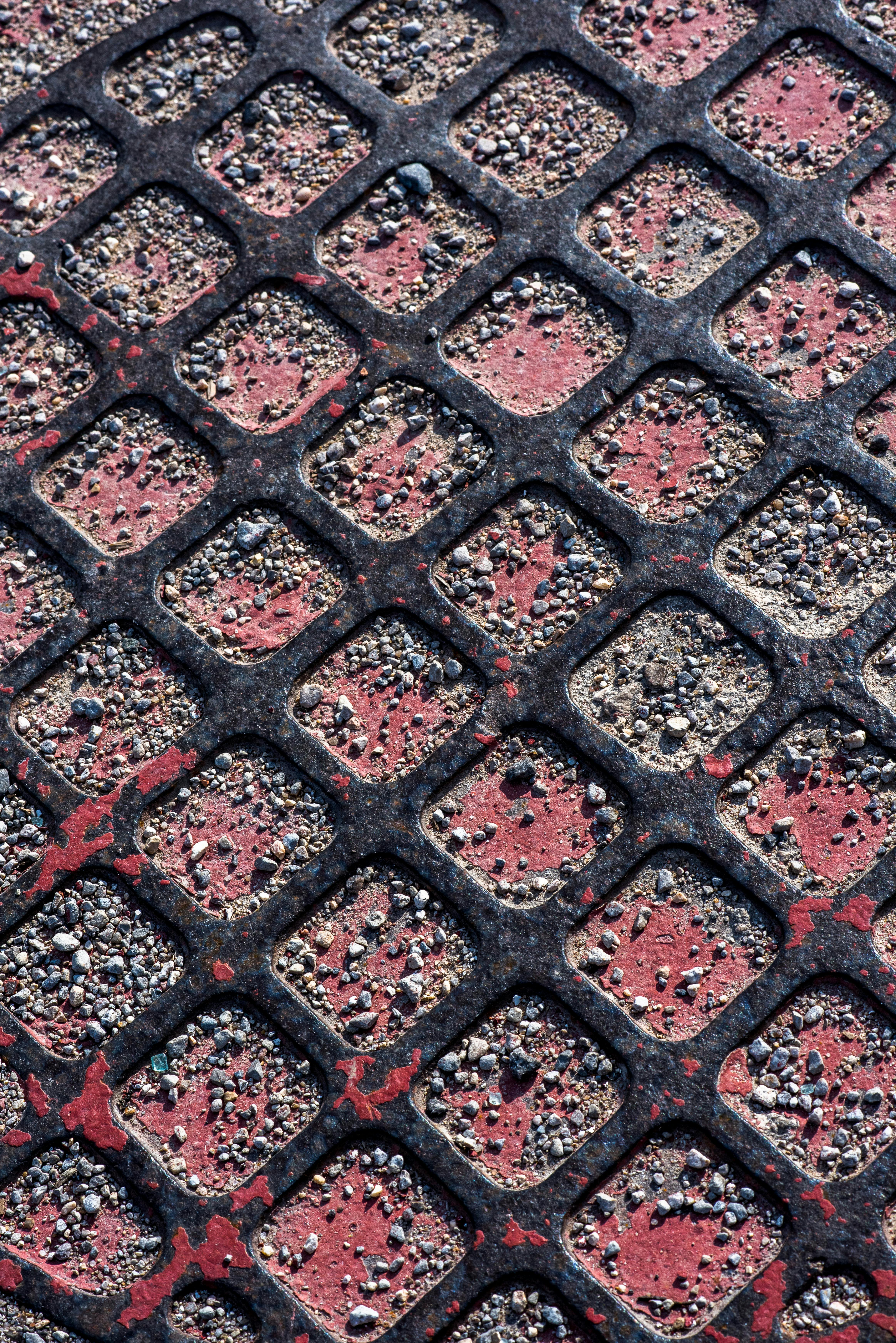 Geometric Metal Grid with Pebbles and Red Paint · Free Stock Photo