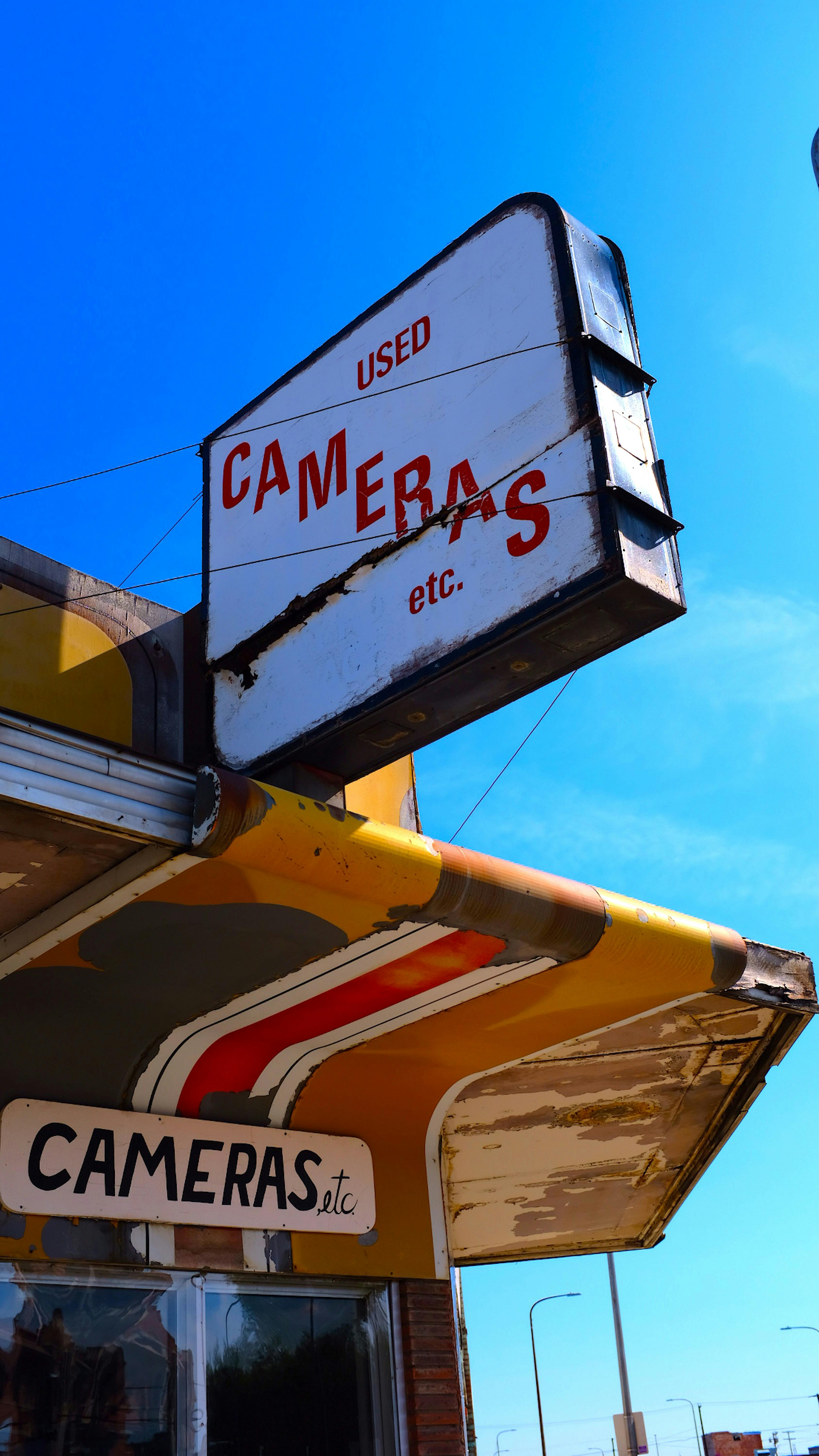 Vintage Camera Store with Weathered Sign · Free Stock Photo