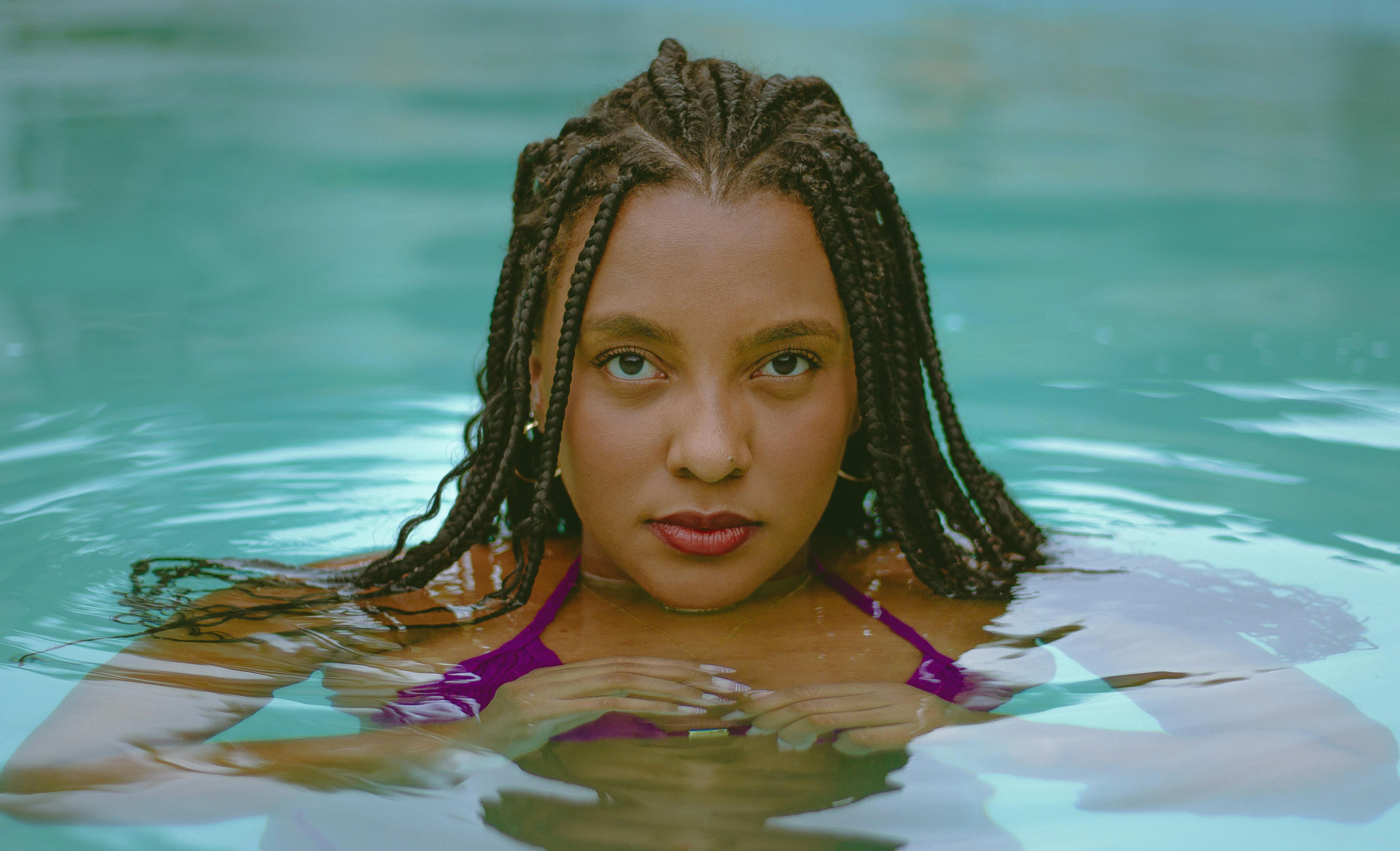 Stunning Portrait of Woman with Braided Hair in Pool · Free Stock Photo