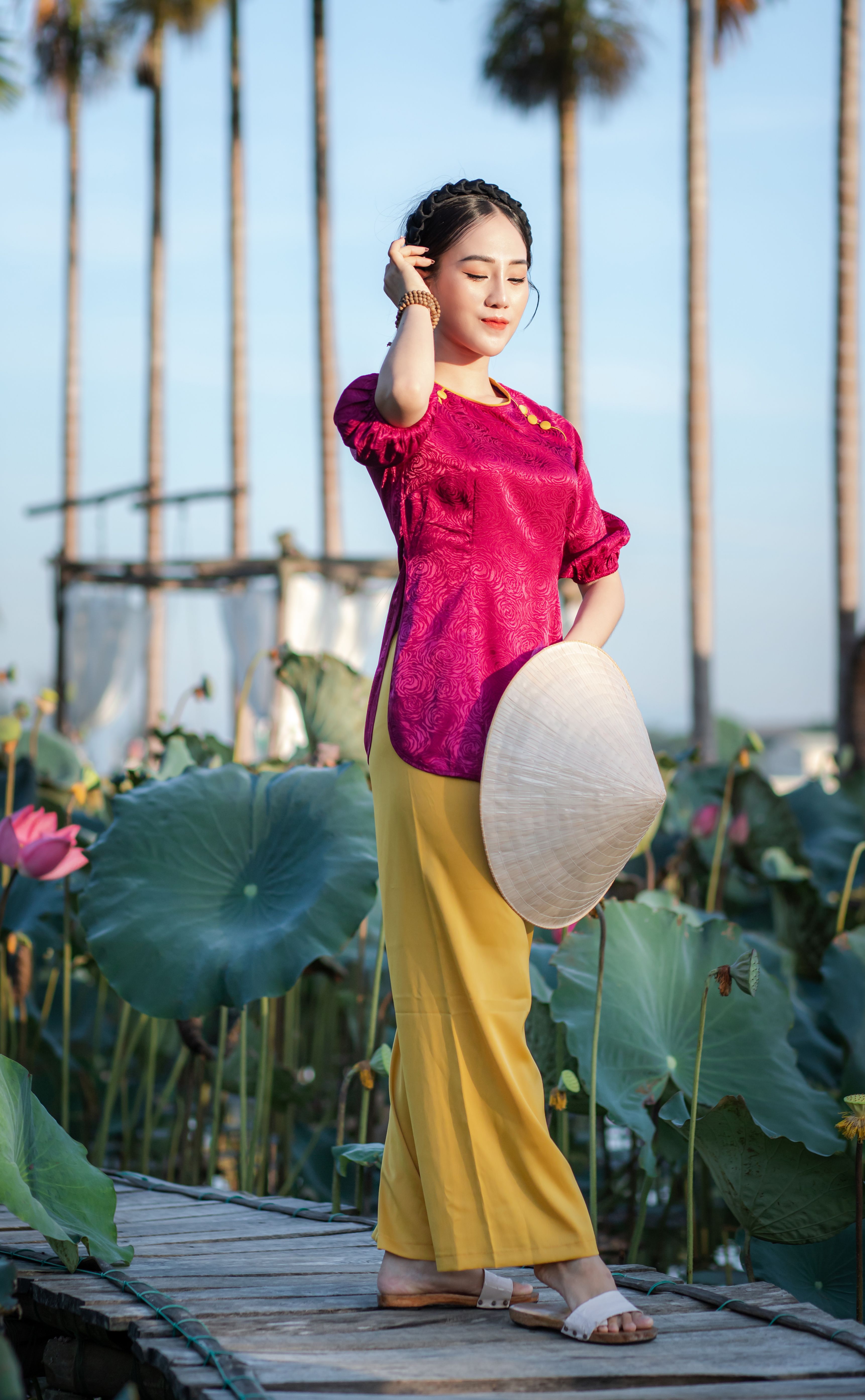 Vietnamese Woman in Traditional Attire by Lotus Pond · Free Stock Photo