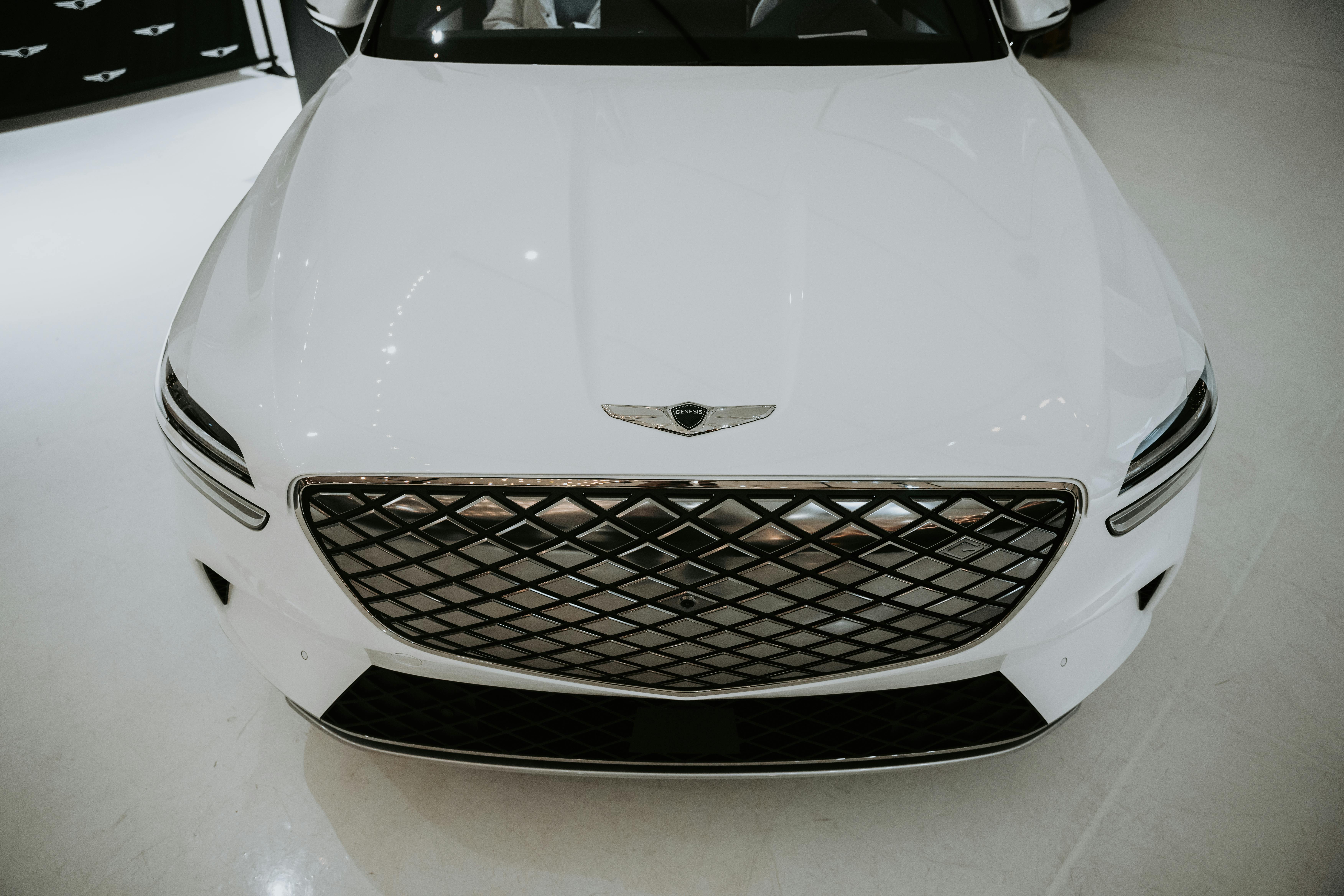 Luxury White Car Front View in Showroom · Free Stock Photo