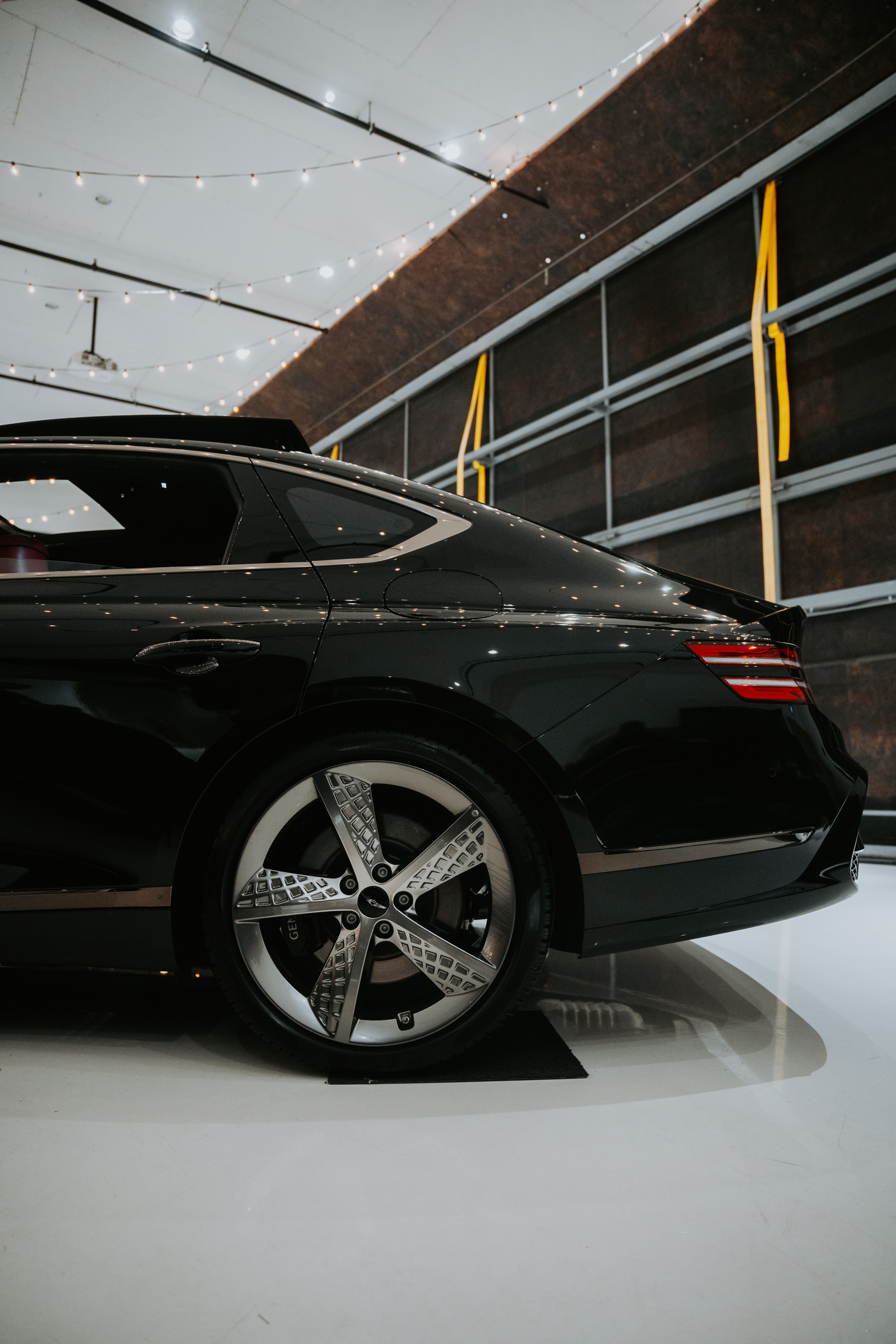 Luxury Black Car in Modern Showroom Setting · Free Stock Photo