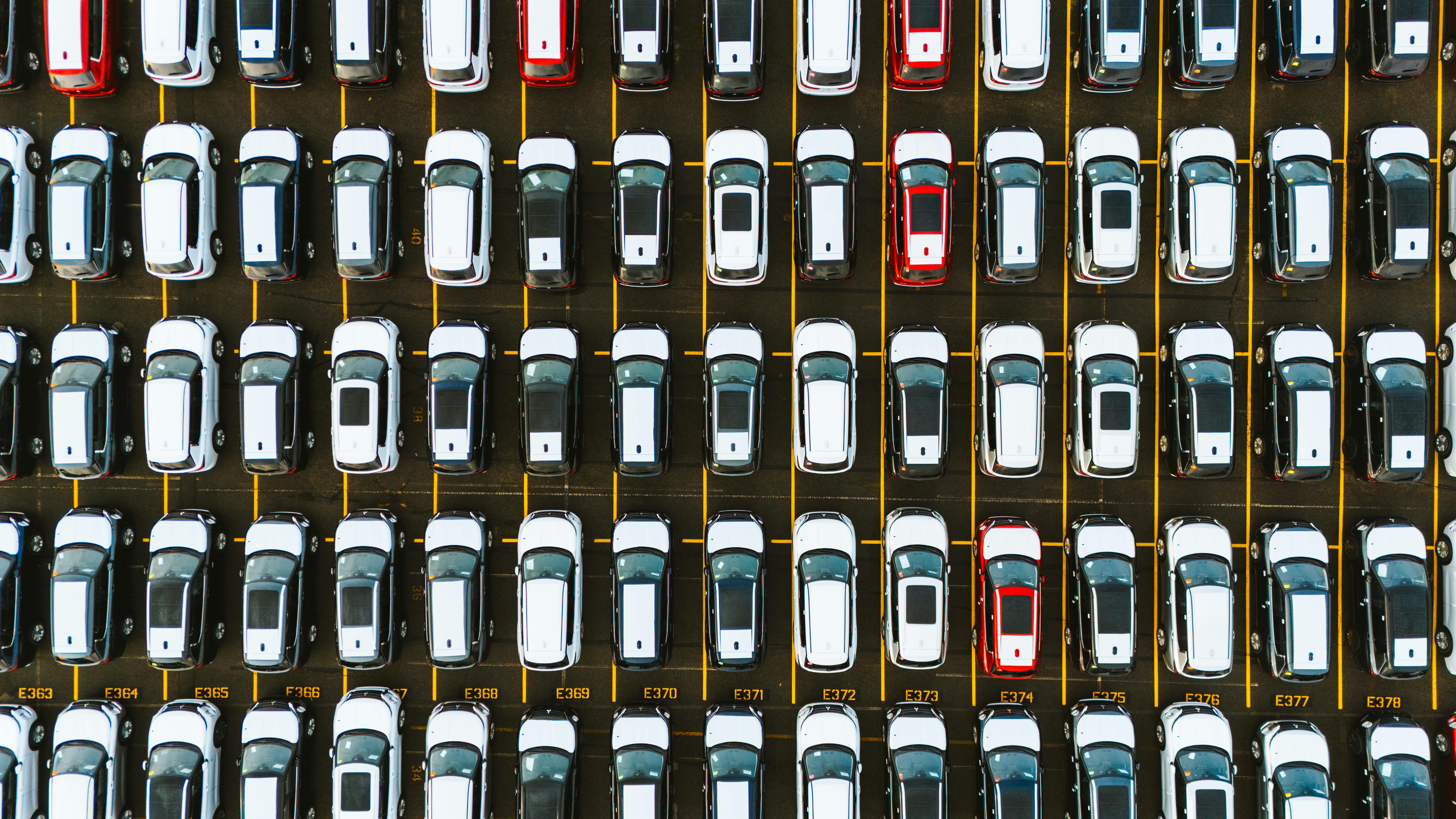 Aerial View of a Symmetrical Car Parking Lot · Free Stock Photo