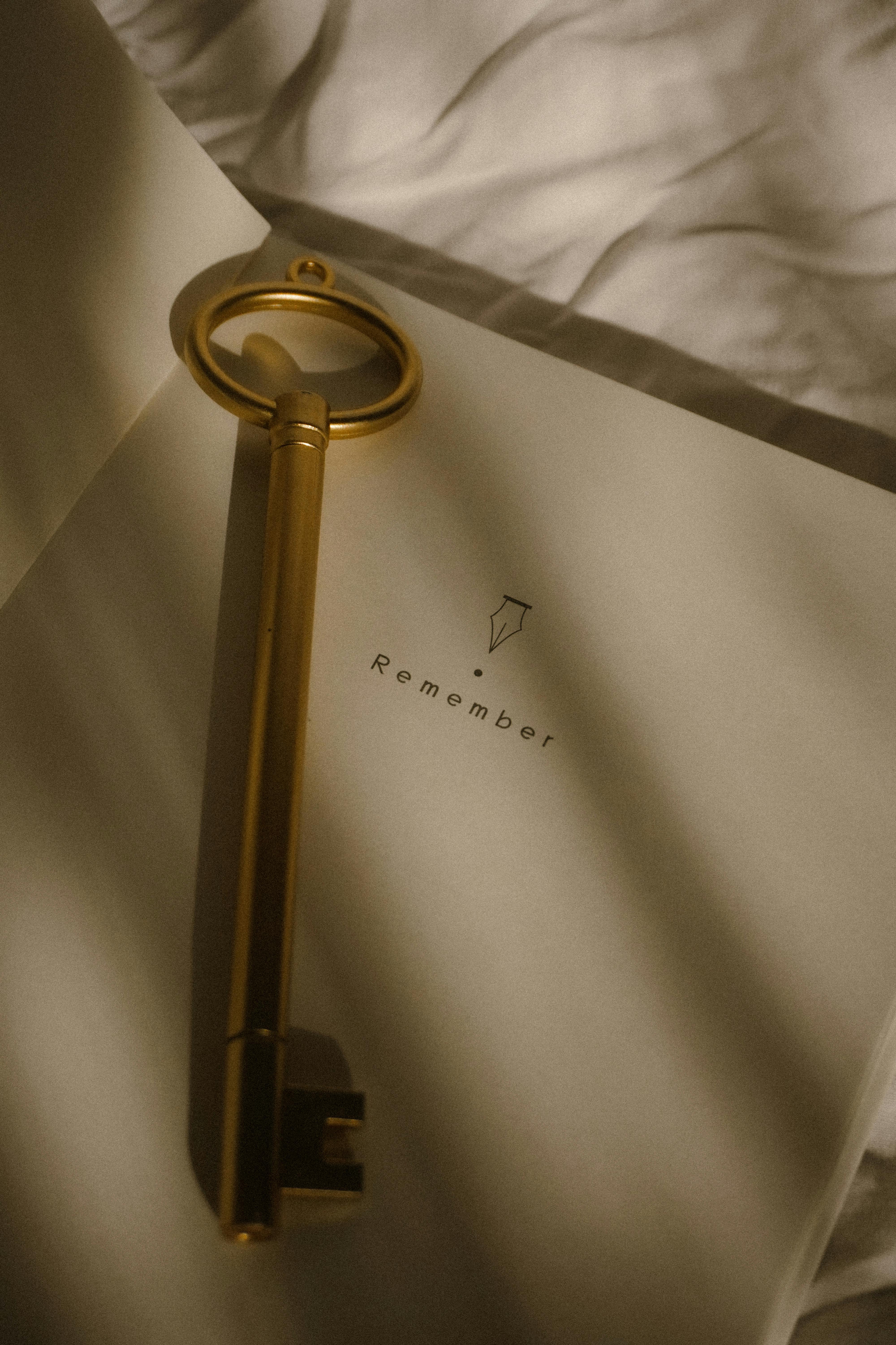 Gold Key on Green Textile · Free Stock Photo