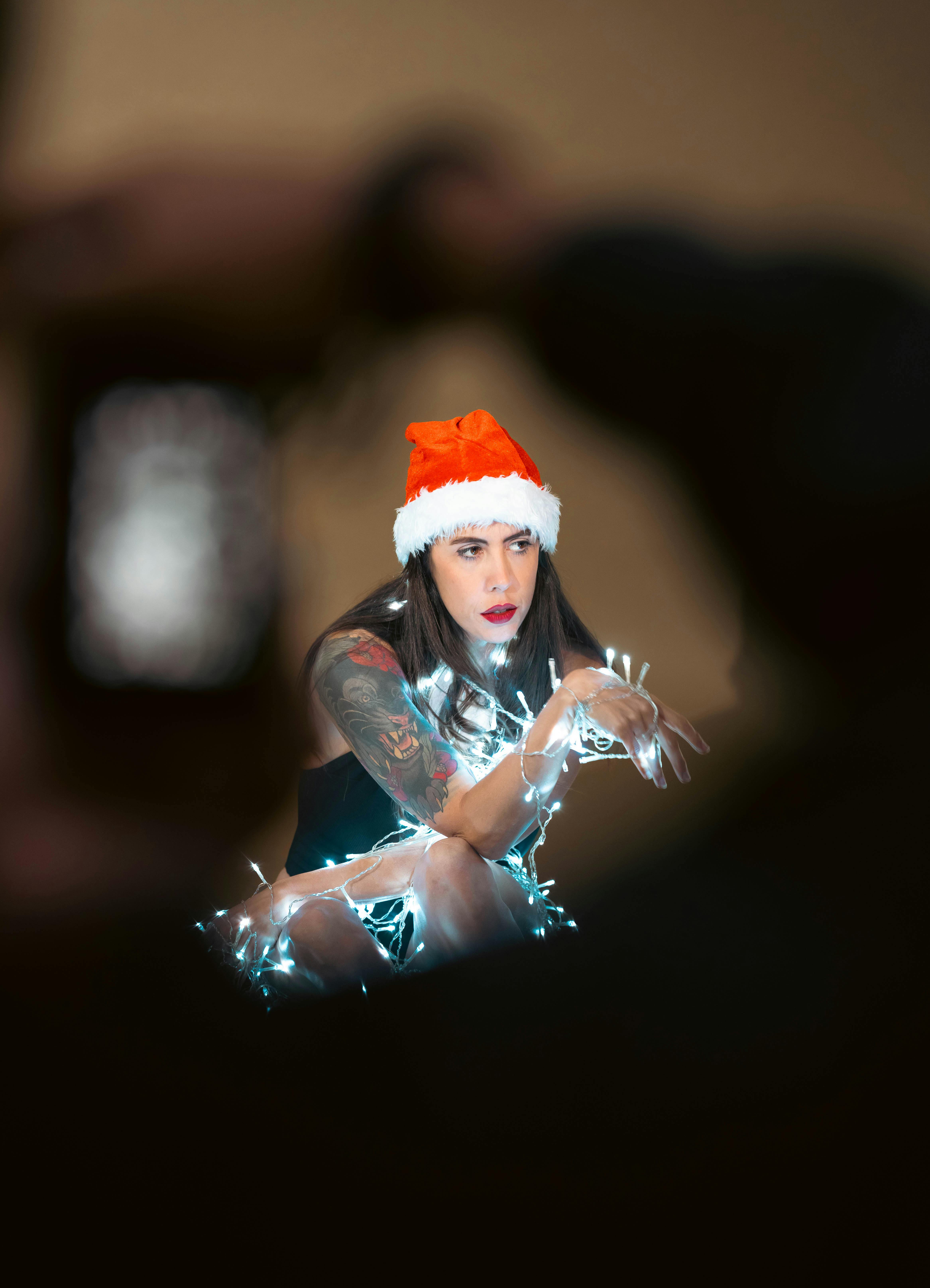 Festive Portrait of a Woman with Christmas Lights · Free Stock Photo