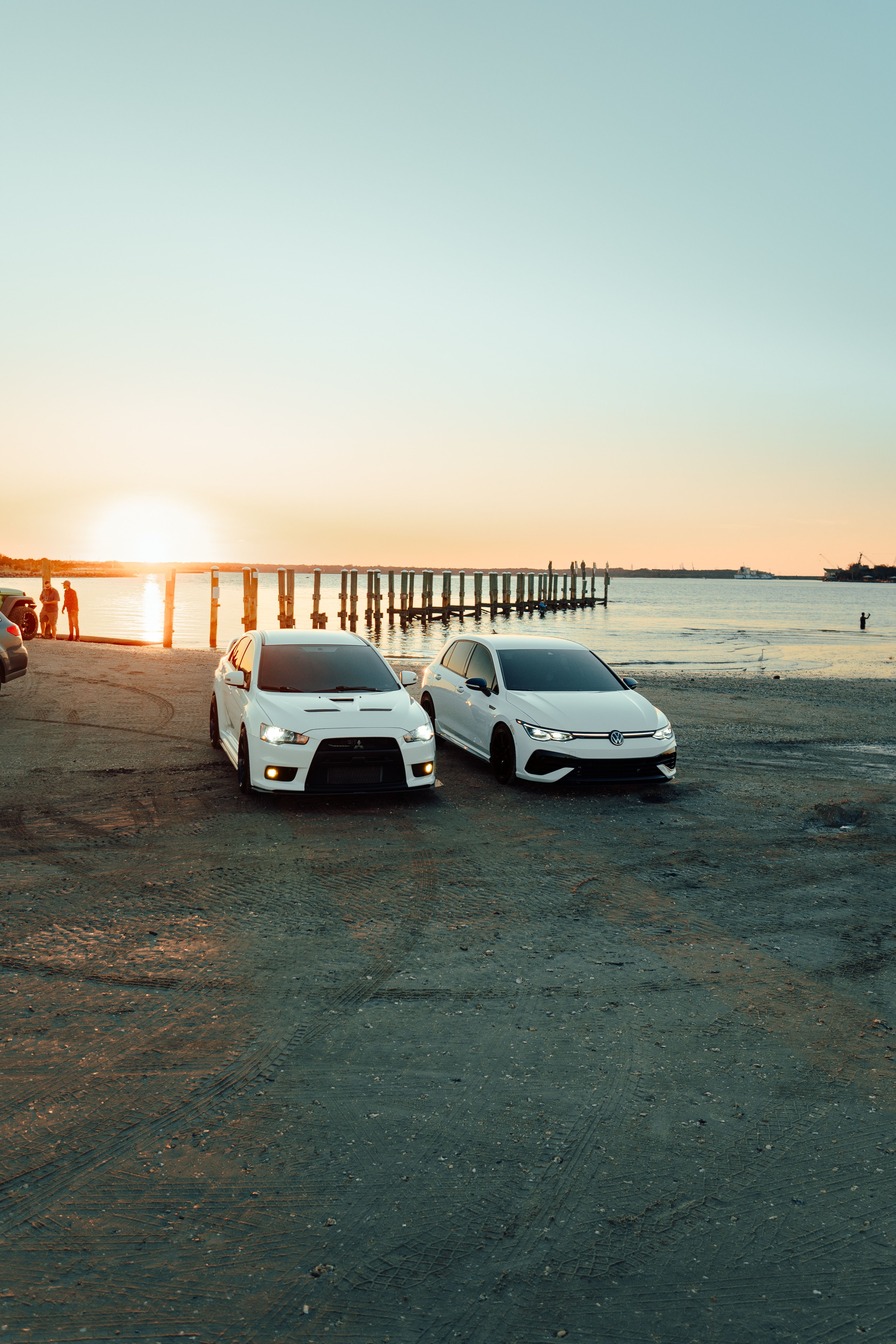 Two Cars Parked by the Pier at Sunset · Free Stock Photo