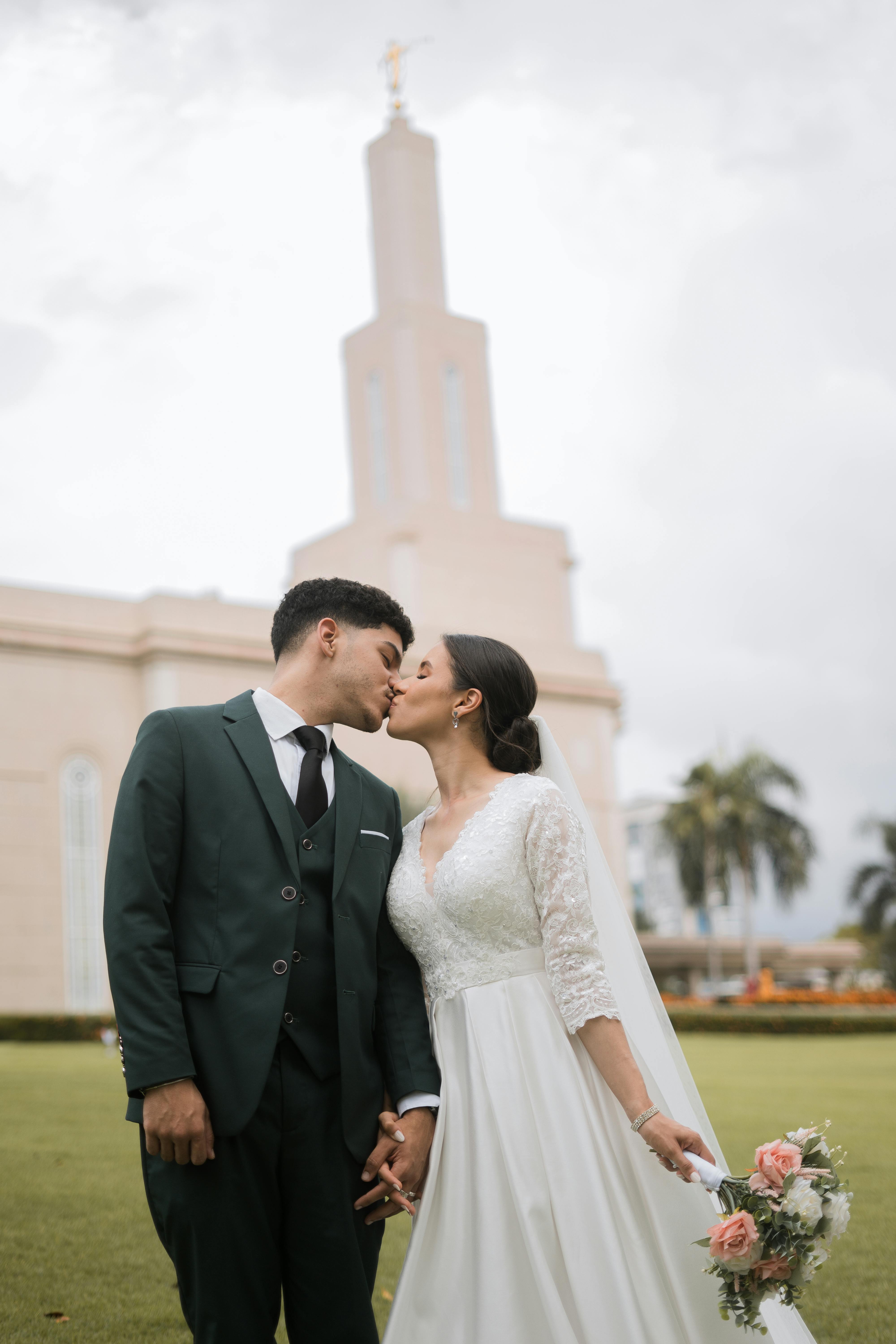 Romantic Wedding Kiss at Santo Domingo Temple · Free Stock Photo