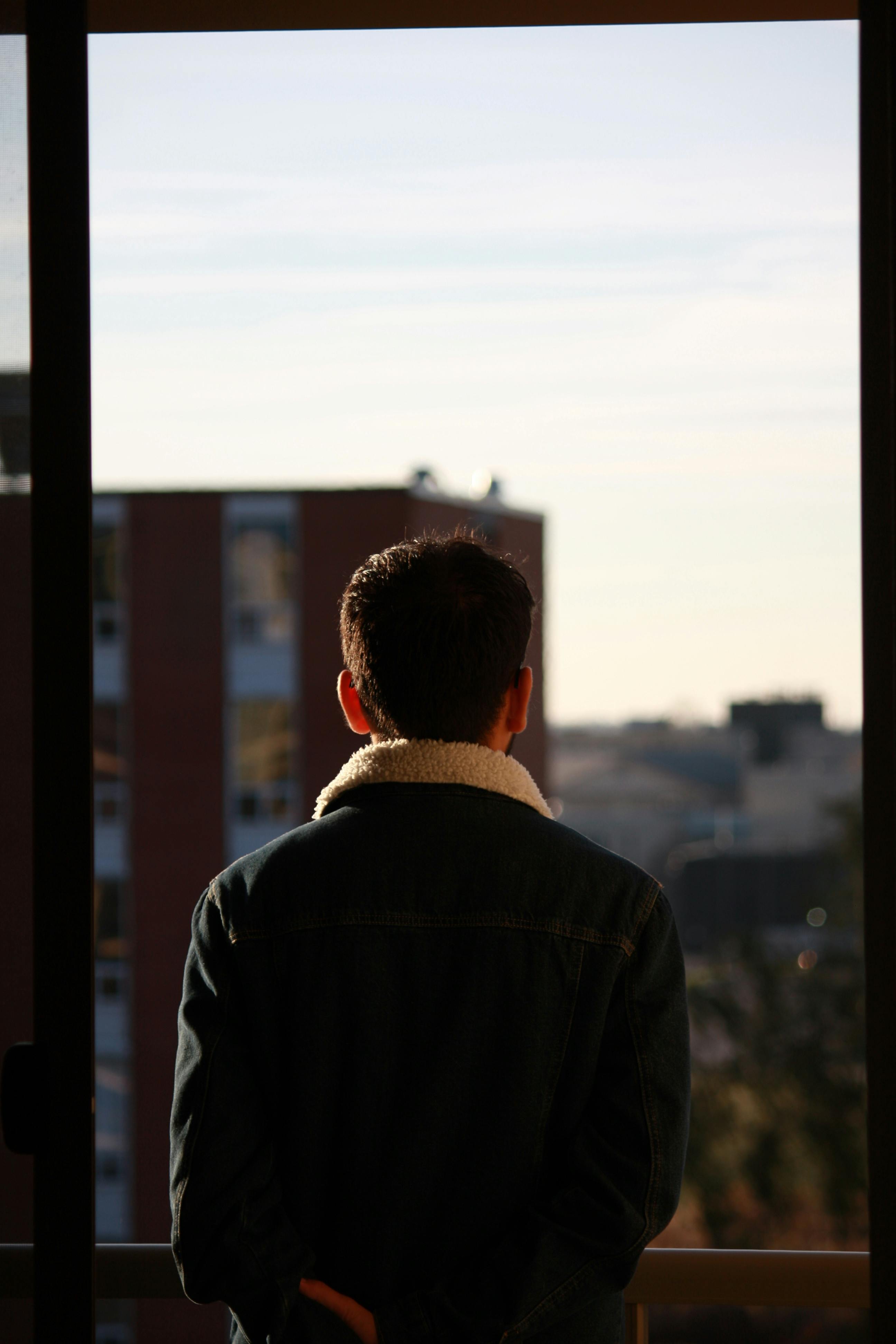 Person Looking Out from Balcony in Kingston · Free Stock Photo