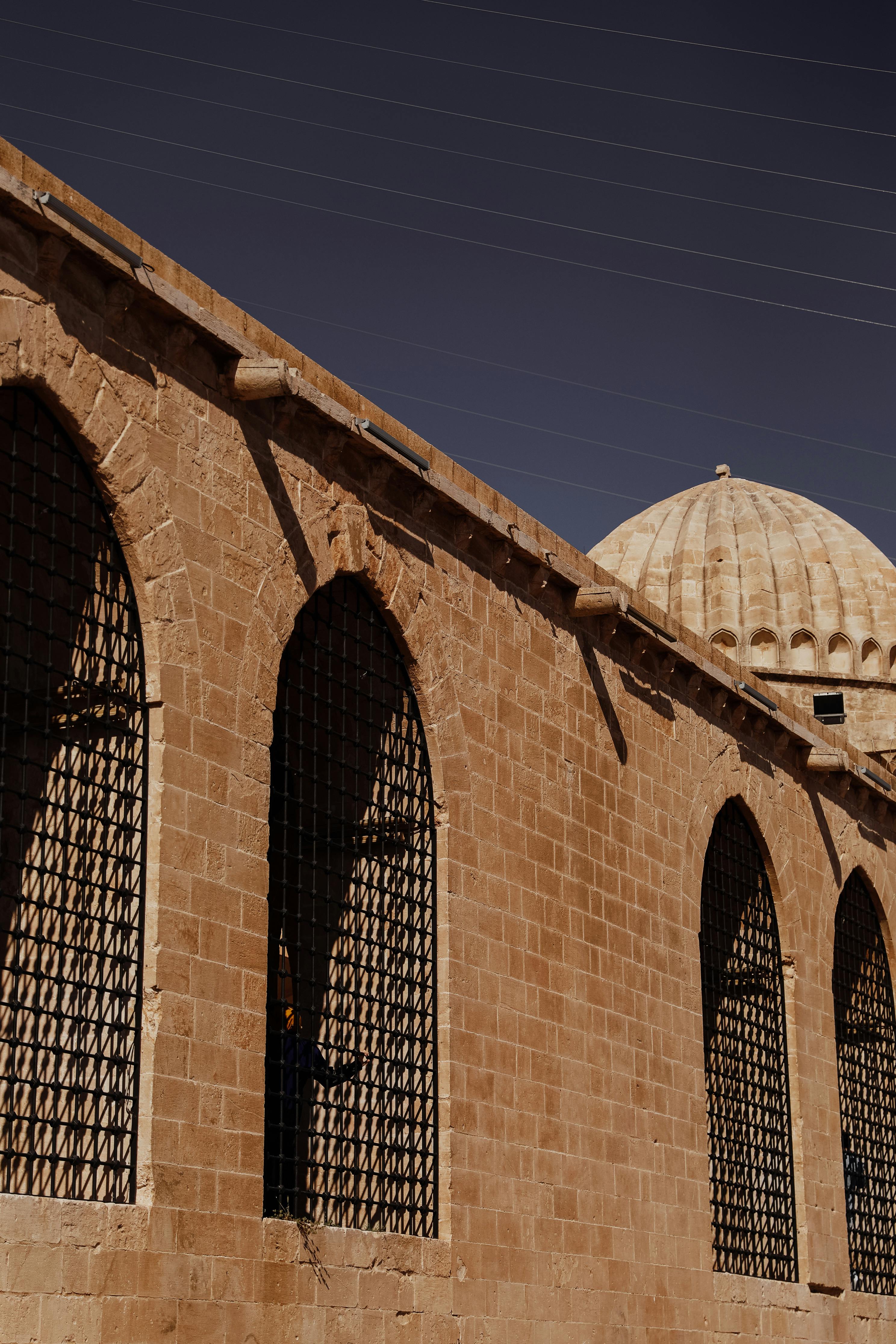 Ancient Stone Architecture with Arched Windows · Free Stock Photo