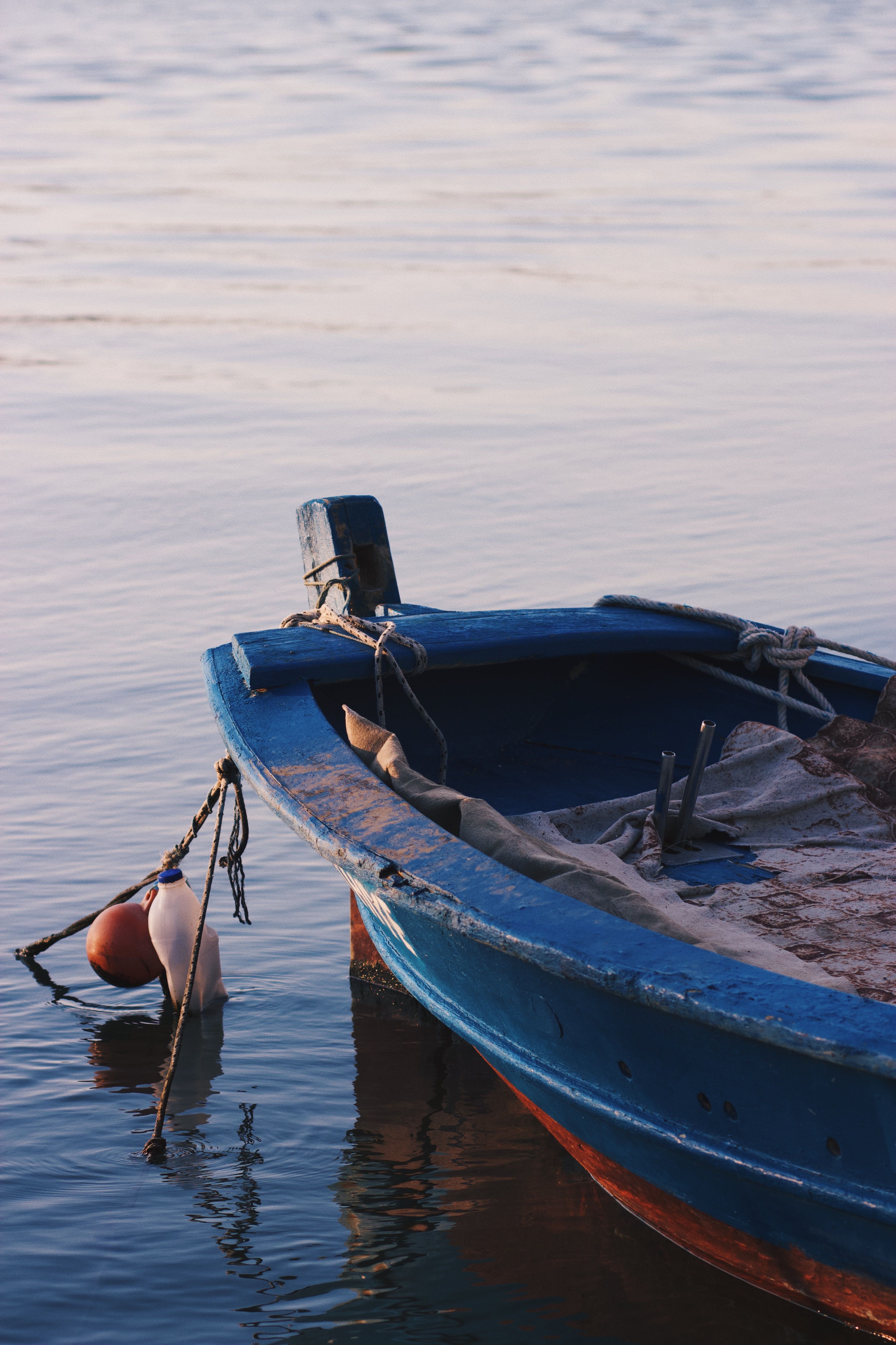 Tranquil Blue Boat on Calm Waters at Sunset · Free Stock Photo