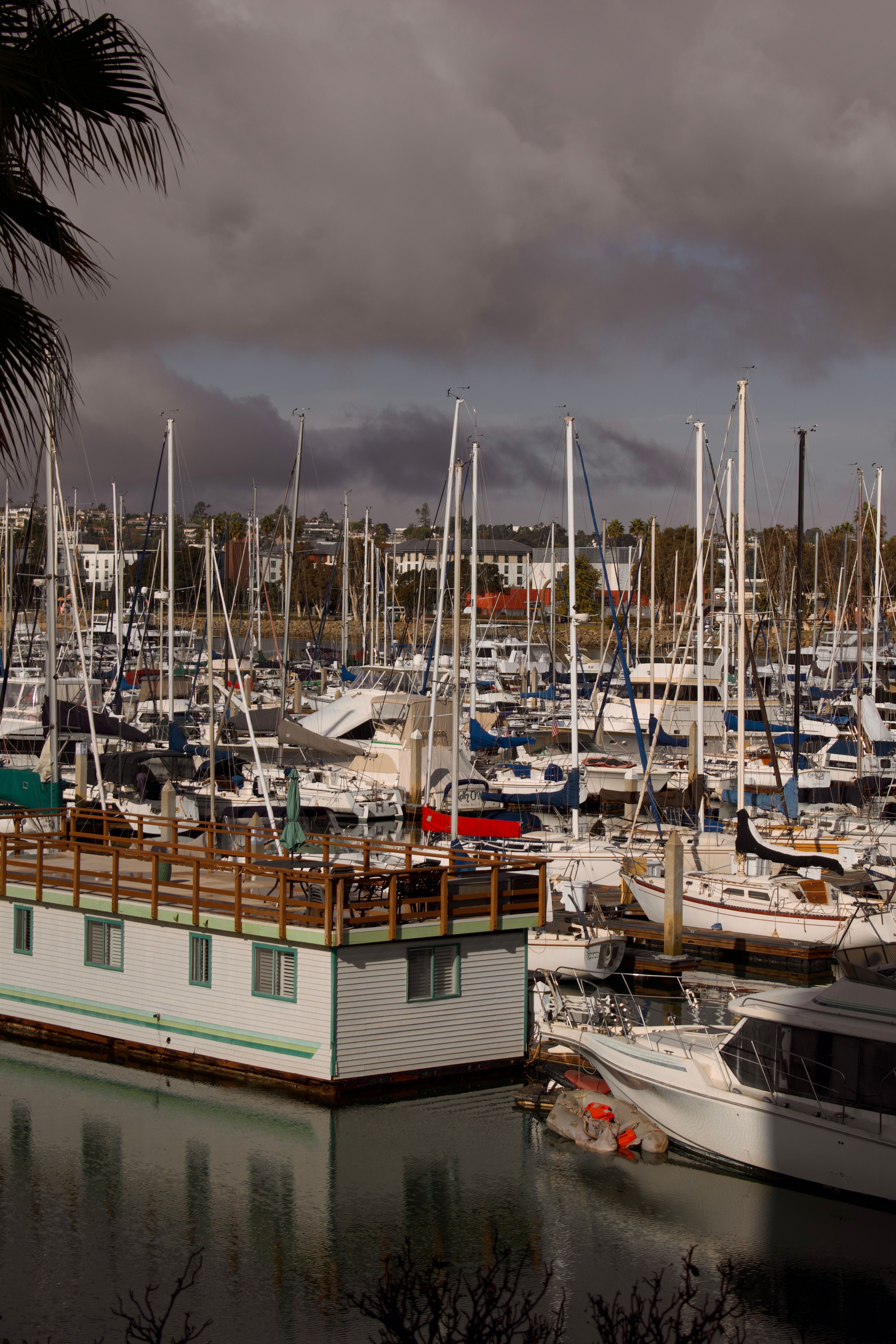 Scenic Marina with Sailboats and Cloudy Sky · Free Stock Photo