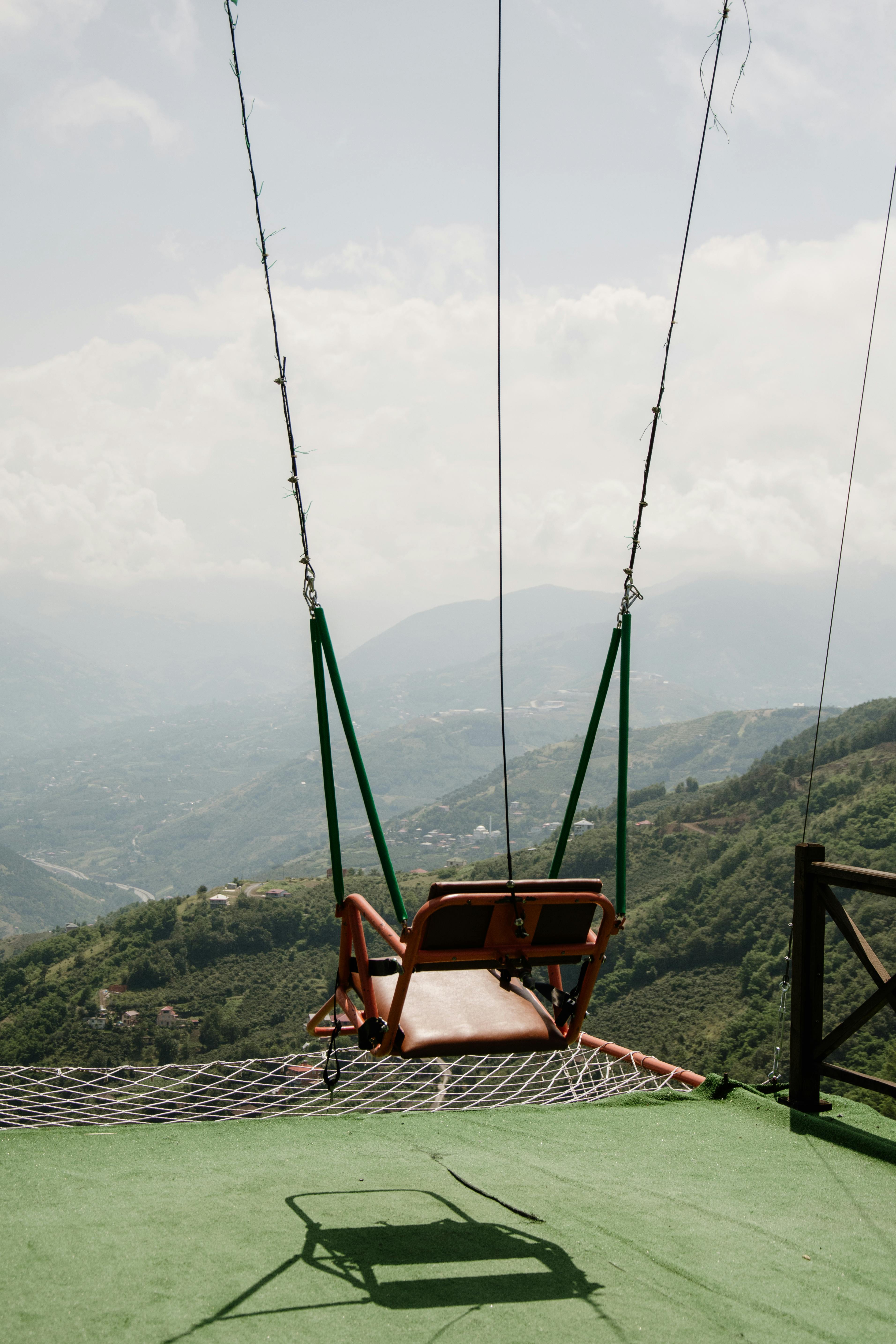 Swing Overlooking Majestic Mountain Range Scenery · Free Stock Photo