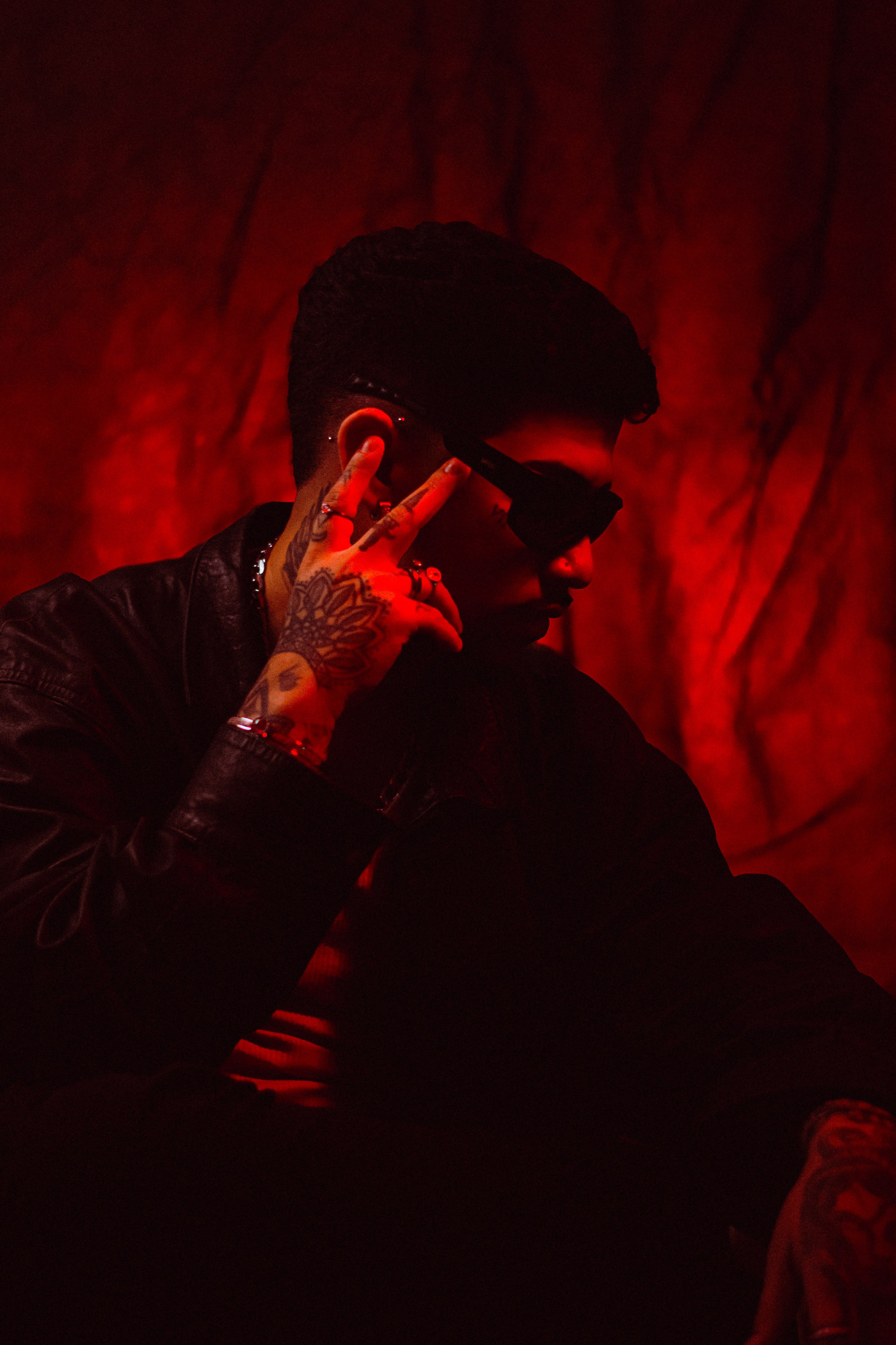 Moody Portrait of a Tattooed Man in Red Light · Free Stock Photo