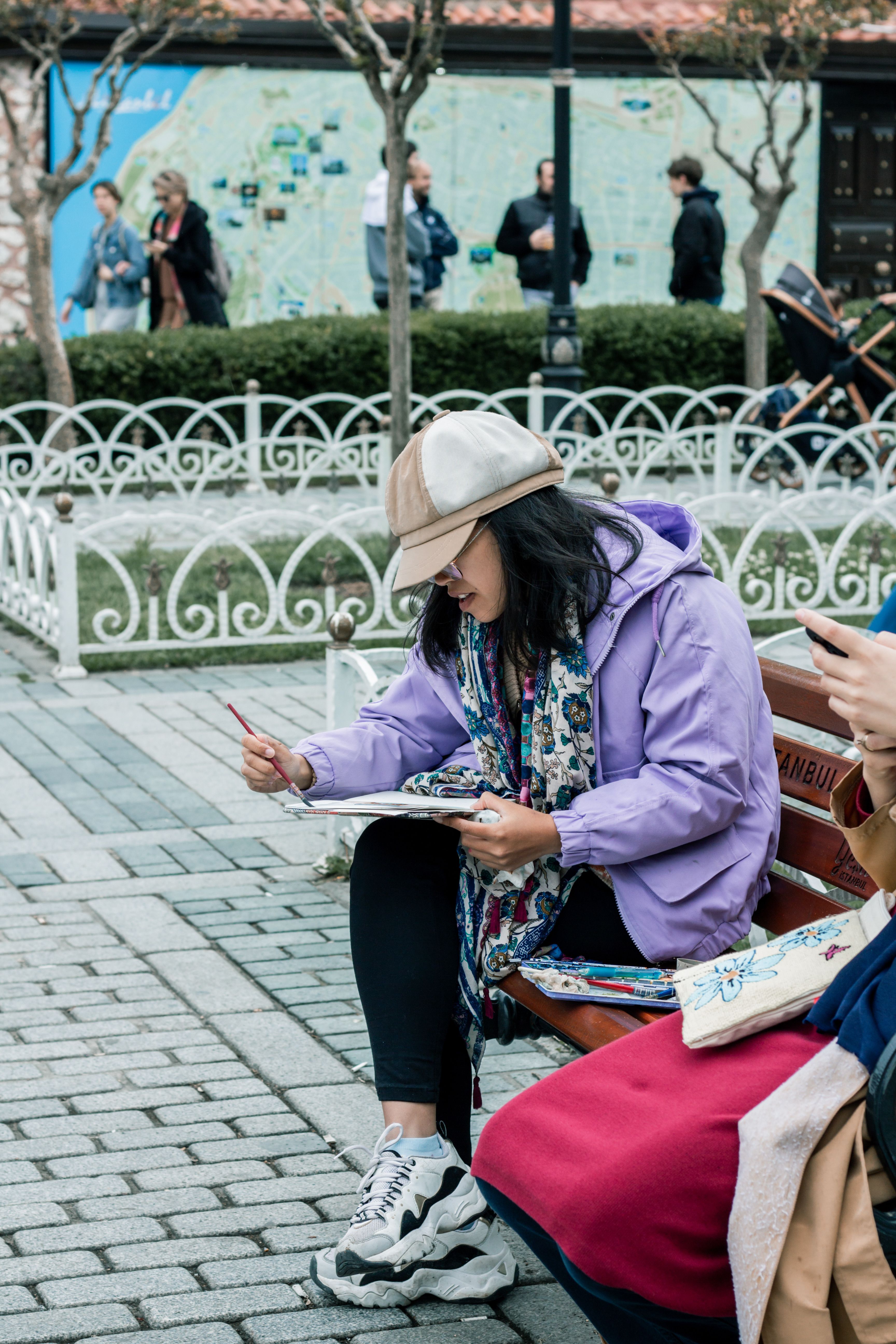 Young Woman Sketching Outdoors in Public Park · Free Stock Photo