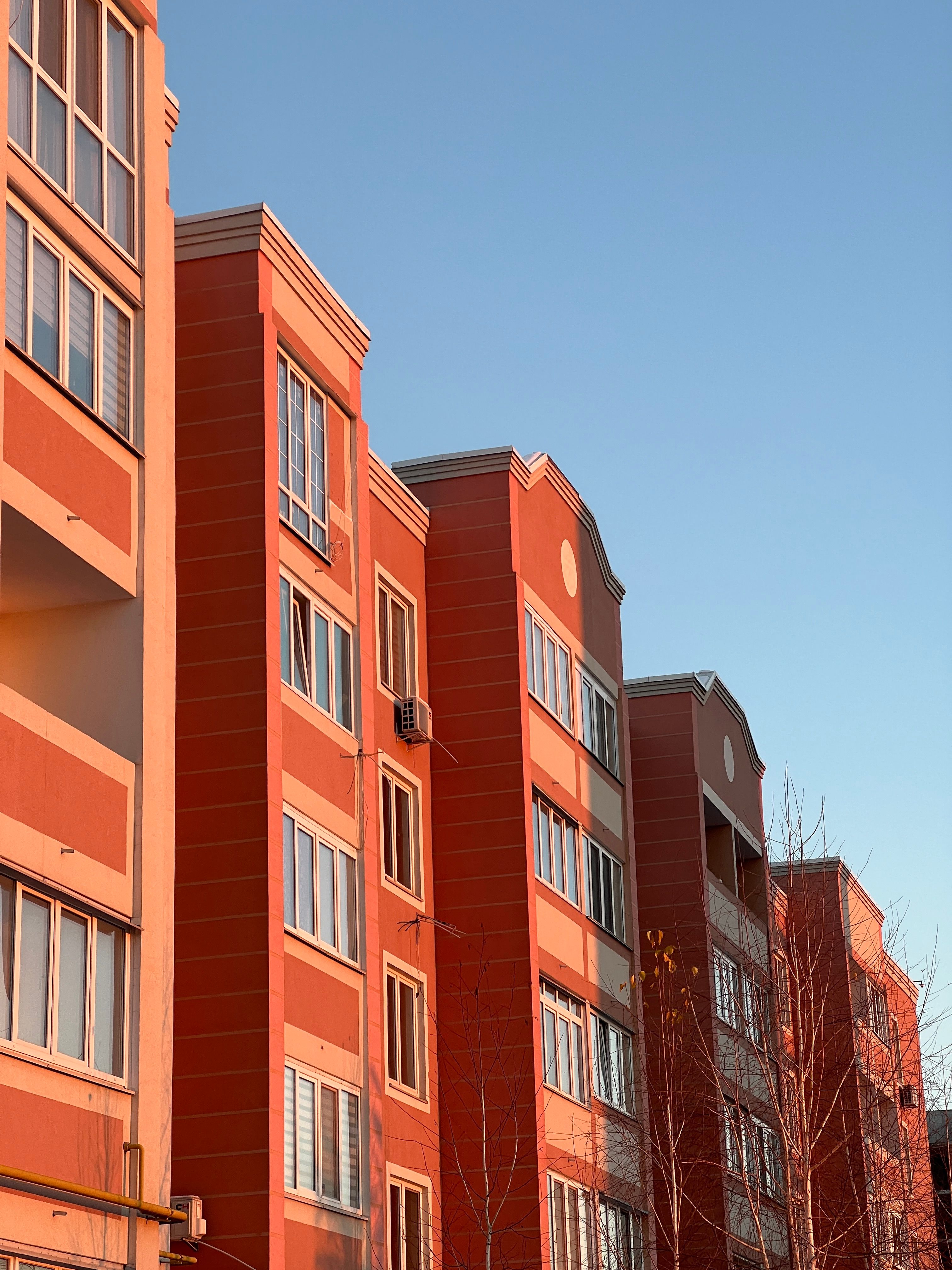 Sunlit Red Brick Apartment Buildings · Free Stock Photo