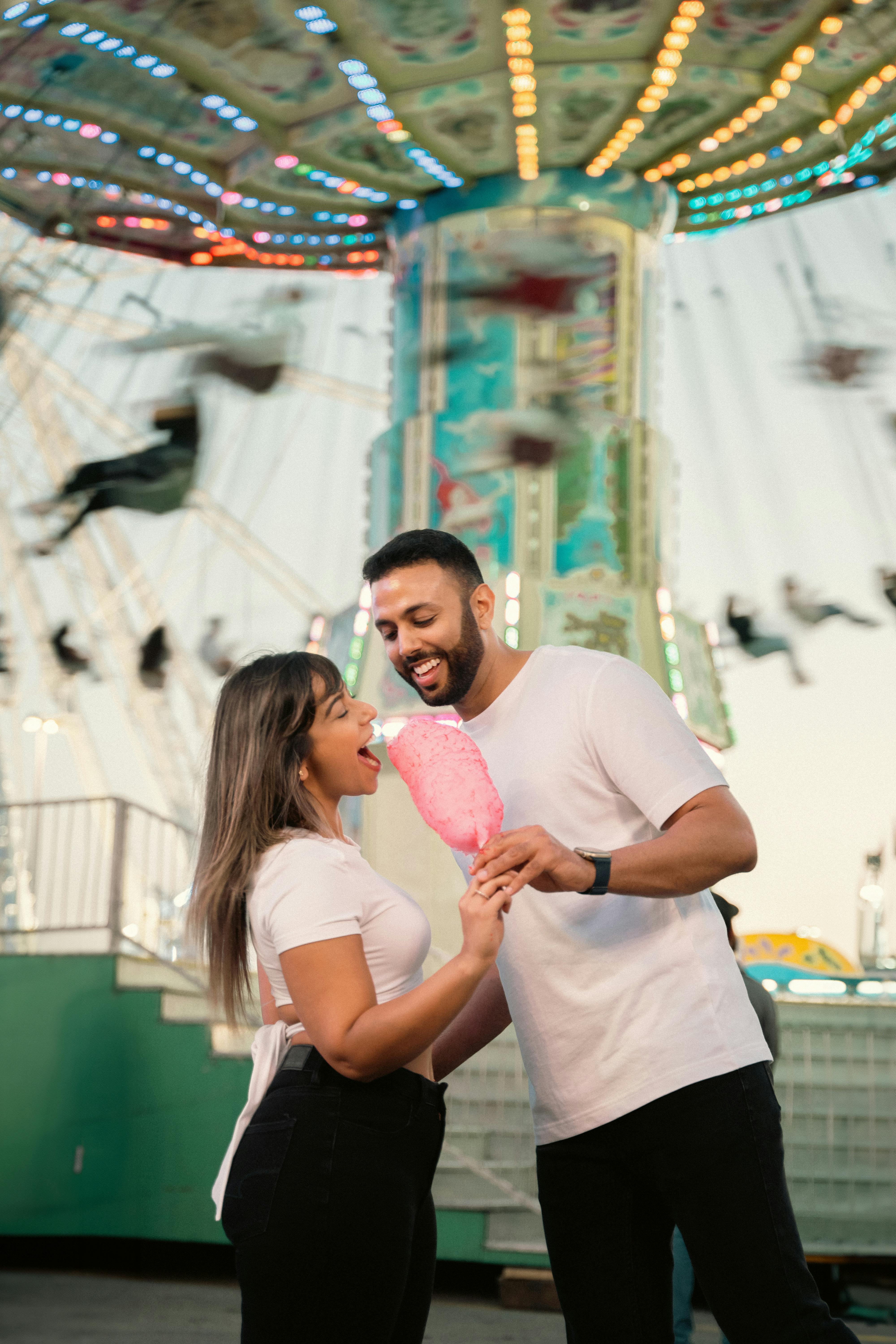 Couple Enjoying Cotton Candy at Carnival · Free Stock Photo
