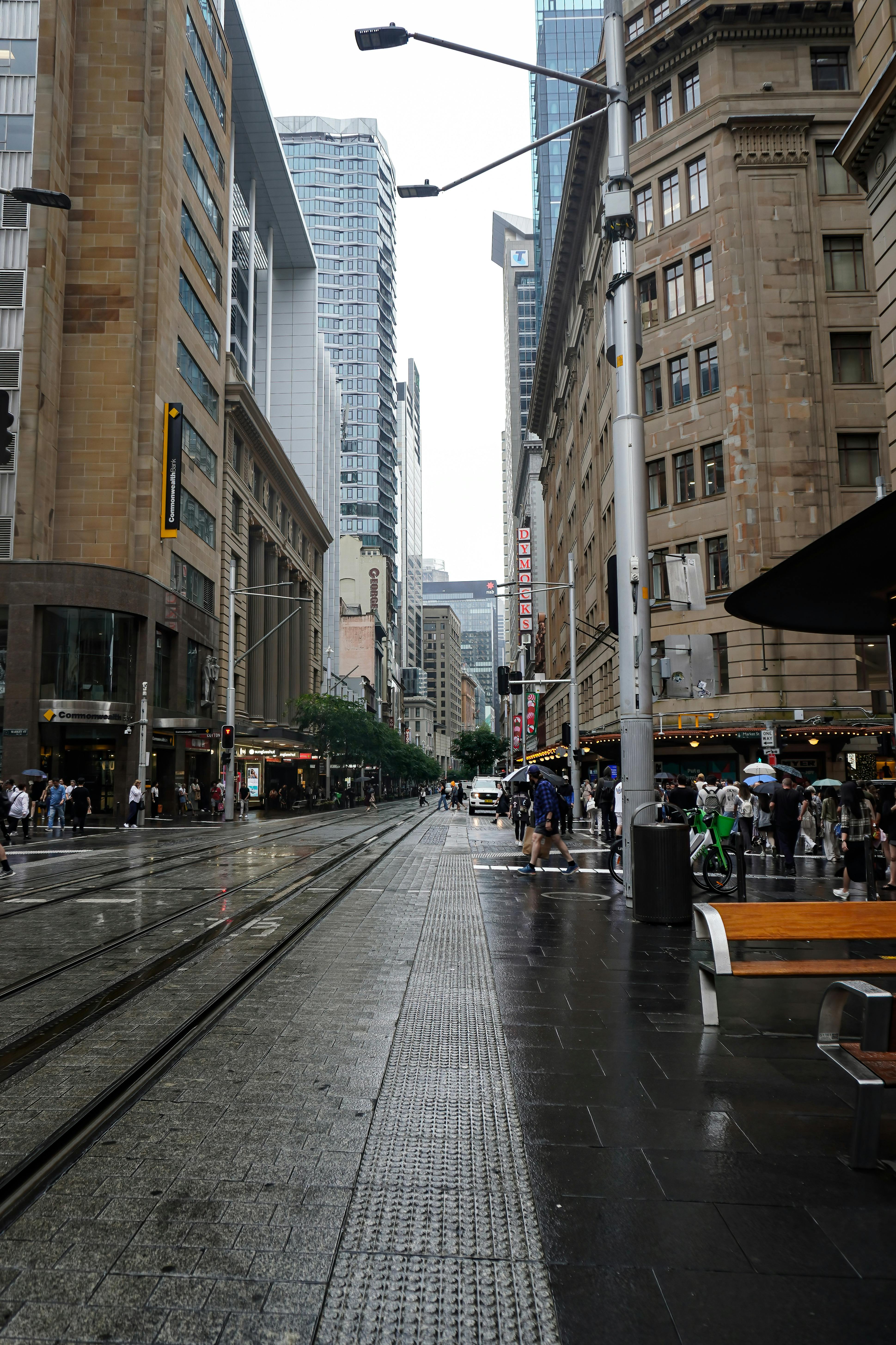Busy Urban Street Scene in Rainy City Center · Free Stock Photo