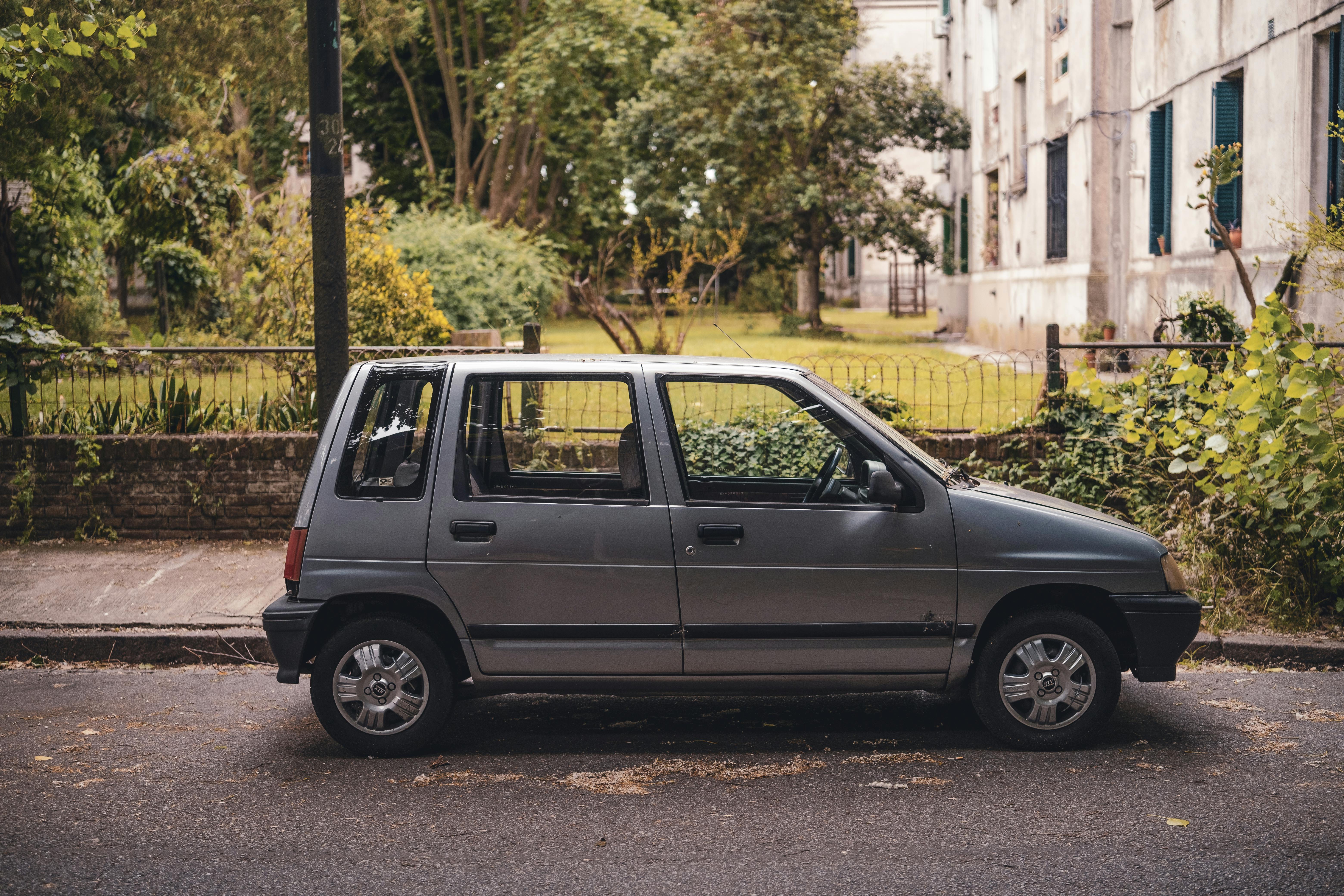 Vintage Compact Car Parked on City Street · Free Stock Photo