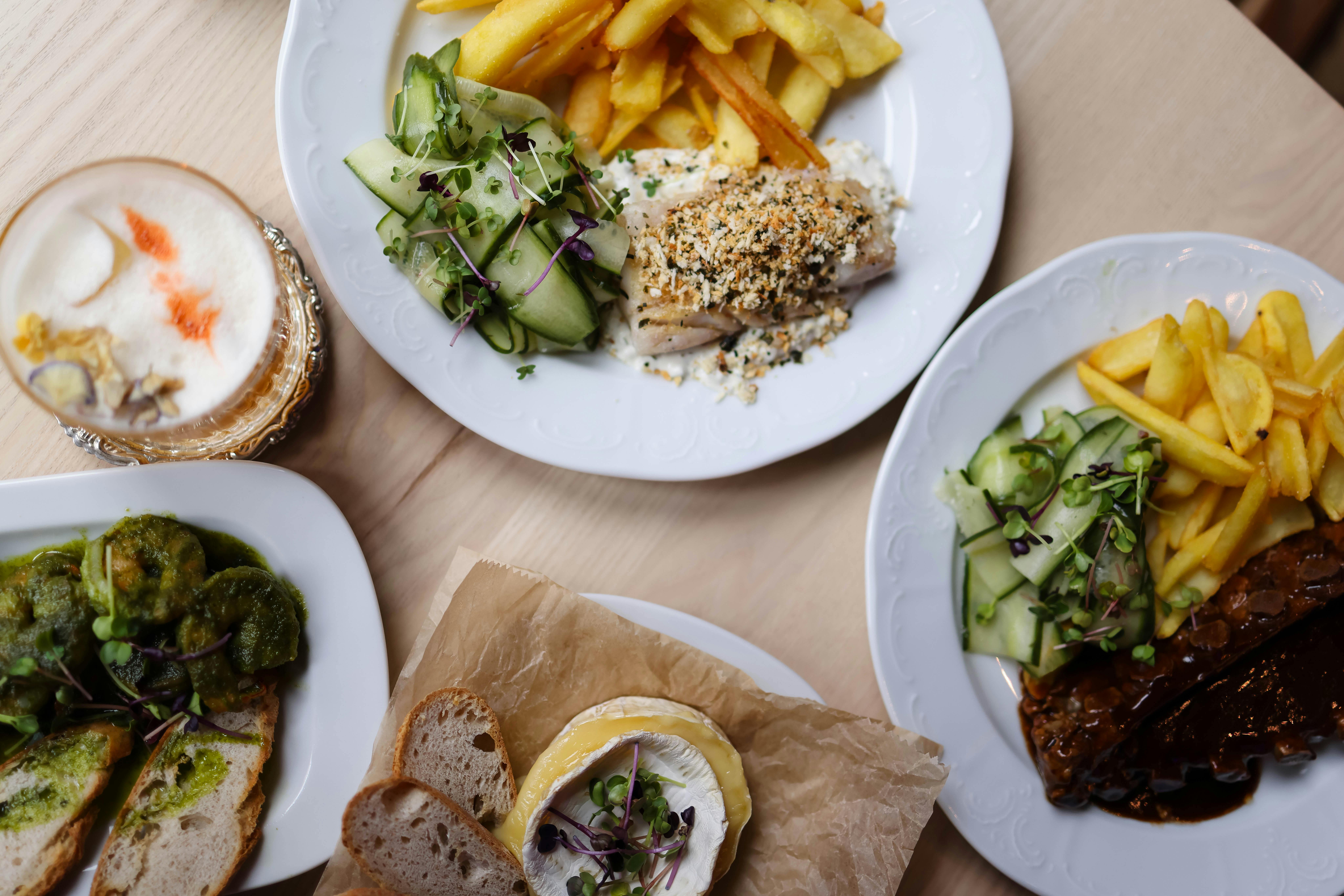 Gourmet Dining Table with Variety of Dishes · Free Stock Photo