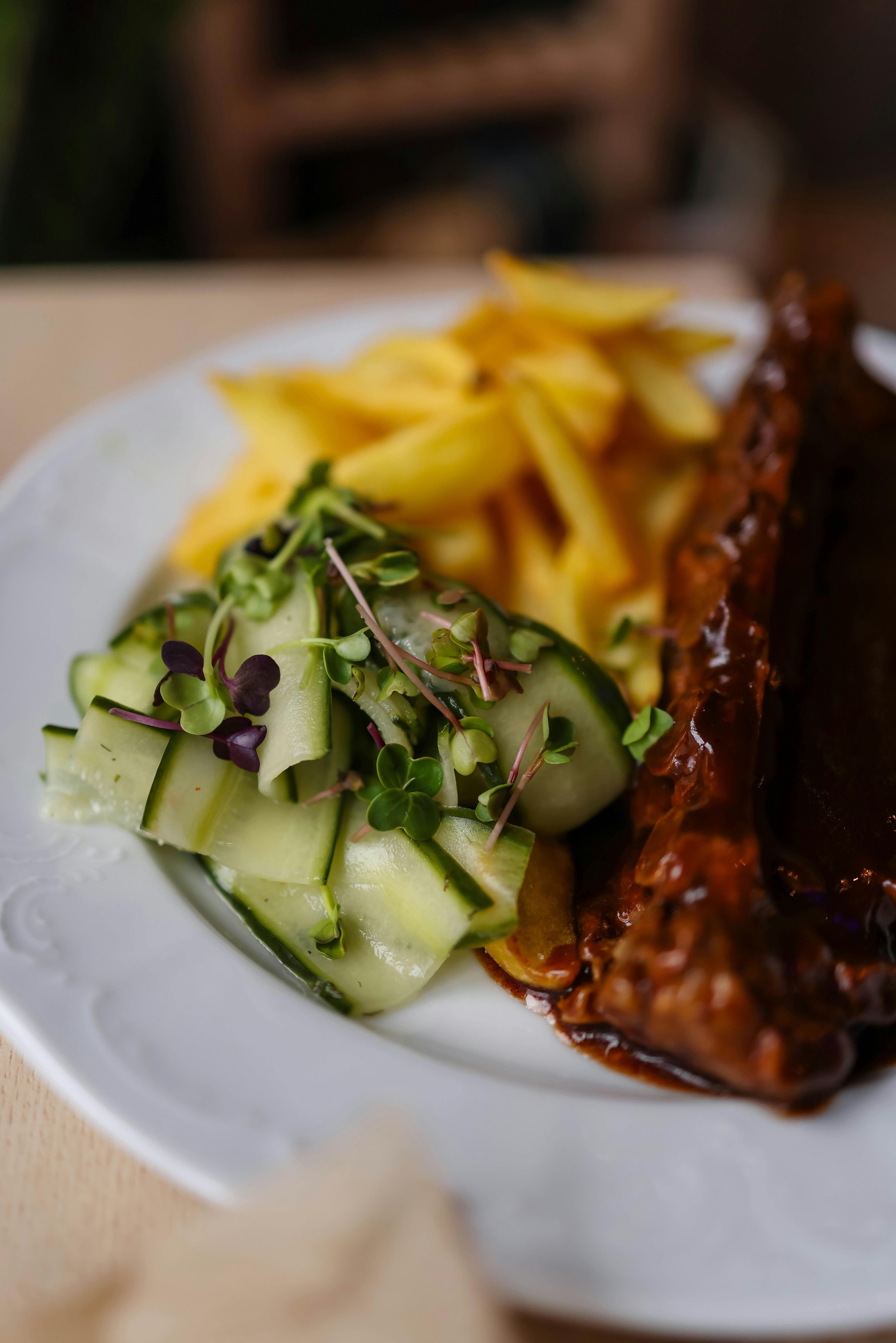 Delicious Barbecue Ribs with Zucchini Salad and Fries · Free Stock Photo