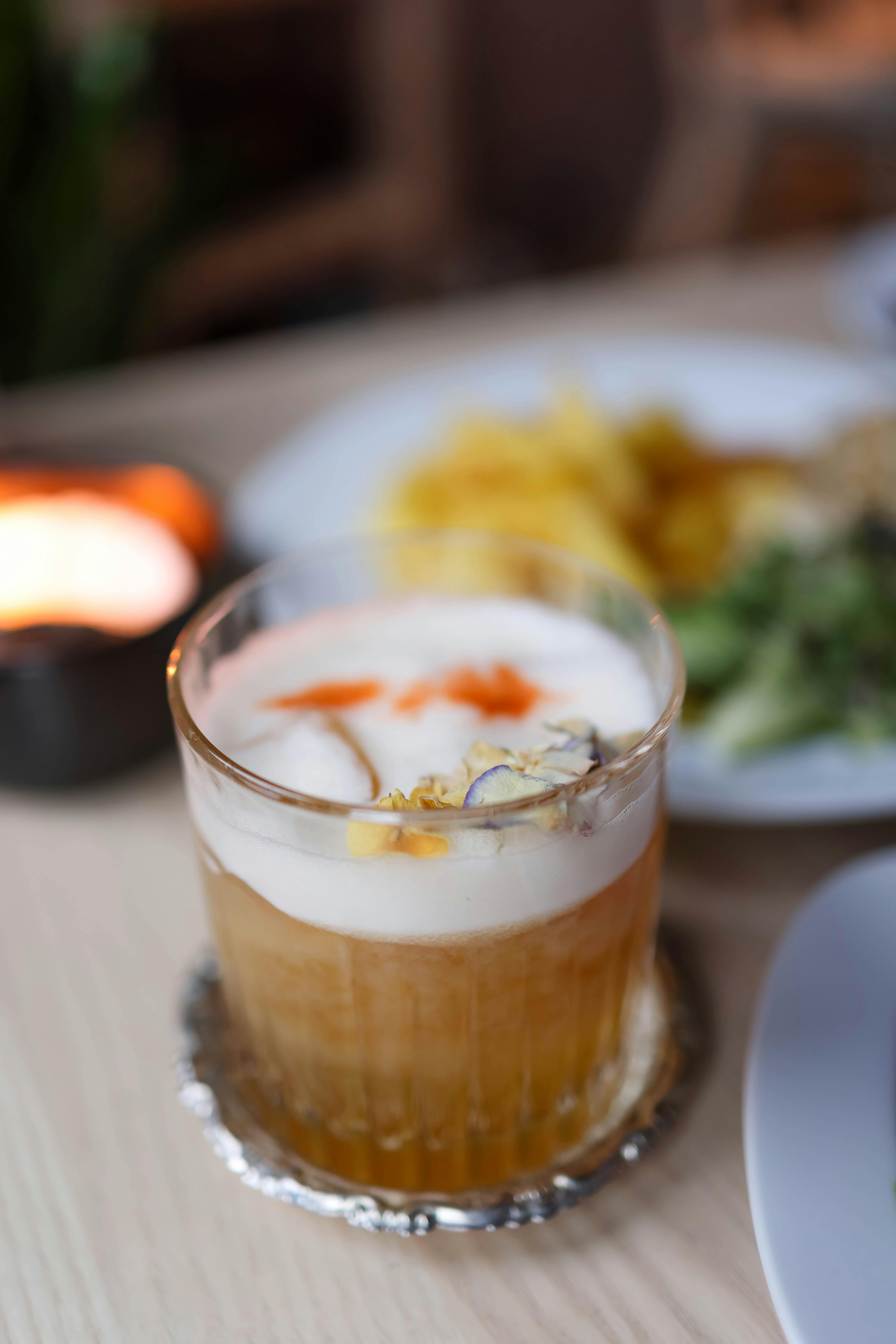 Frothy Cocktail with Edible Flowers and Meal · Free Stock Photo