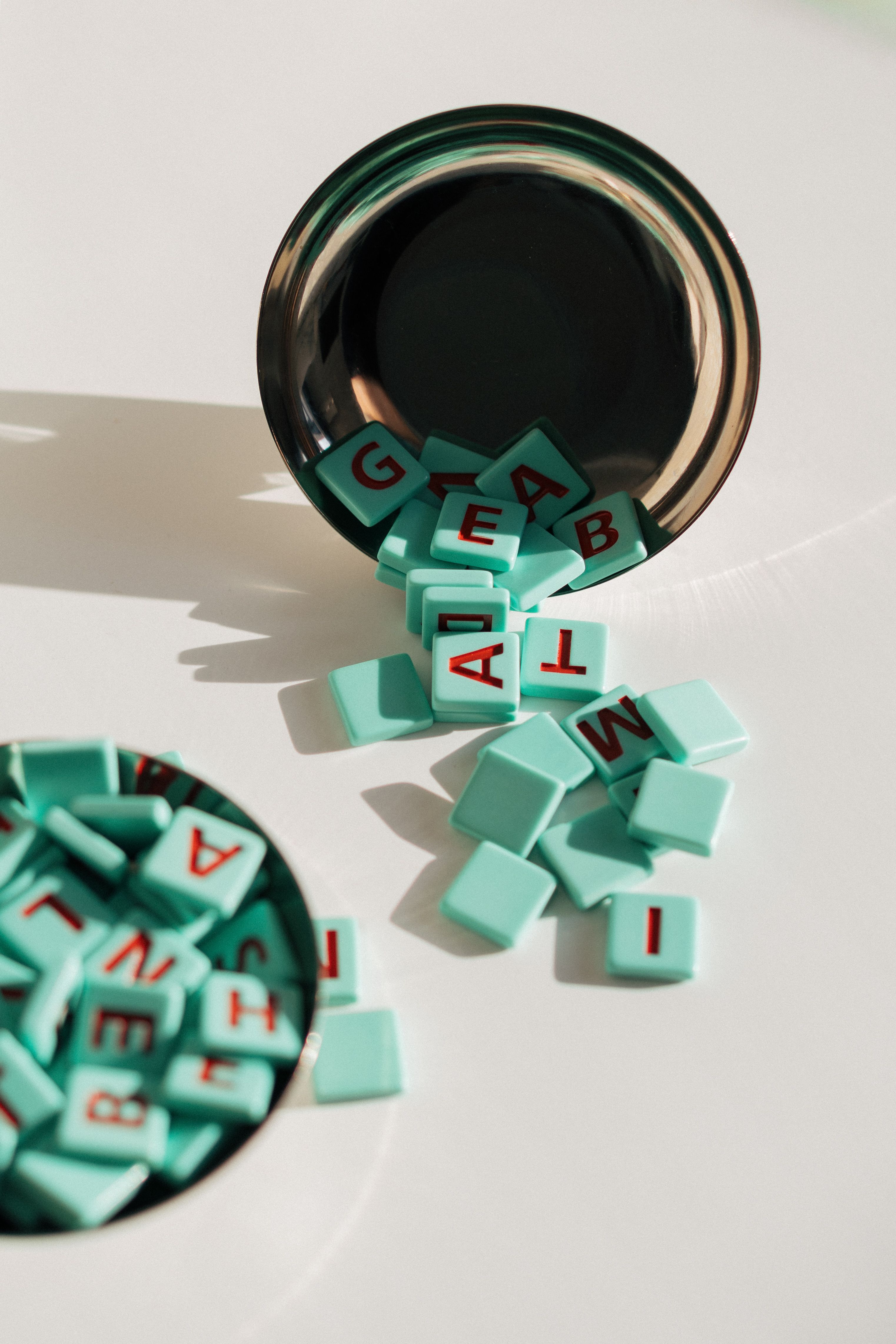 Scattered Alphabet Tiles on White Surface · Free Stock Photo