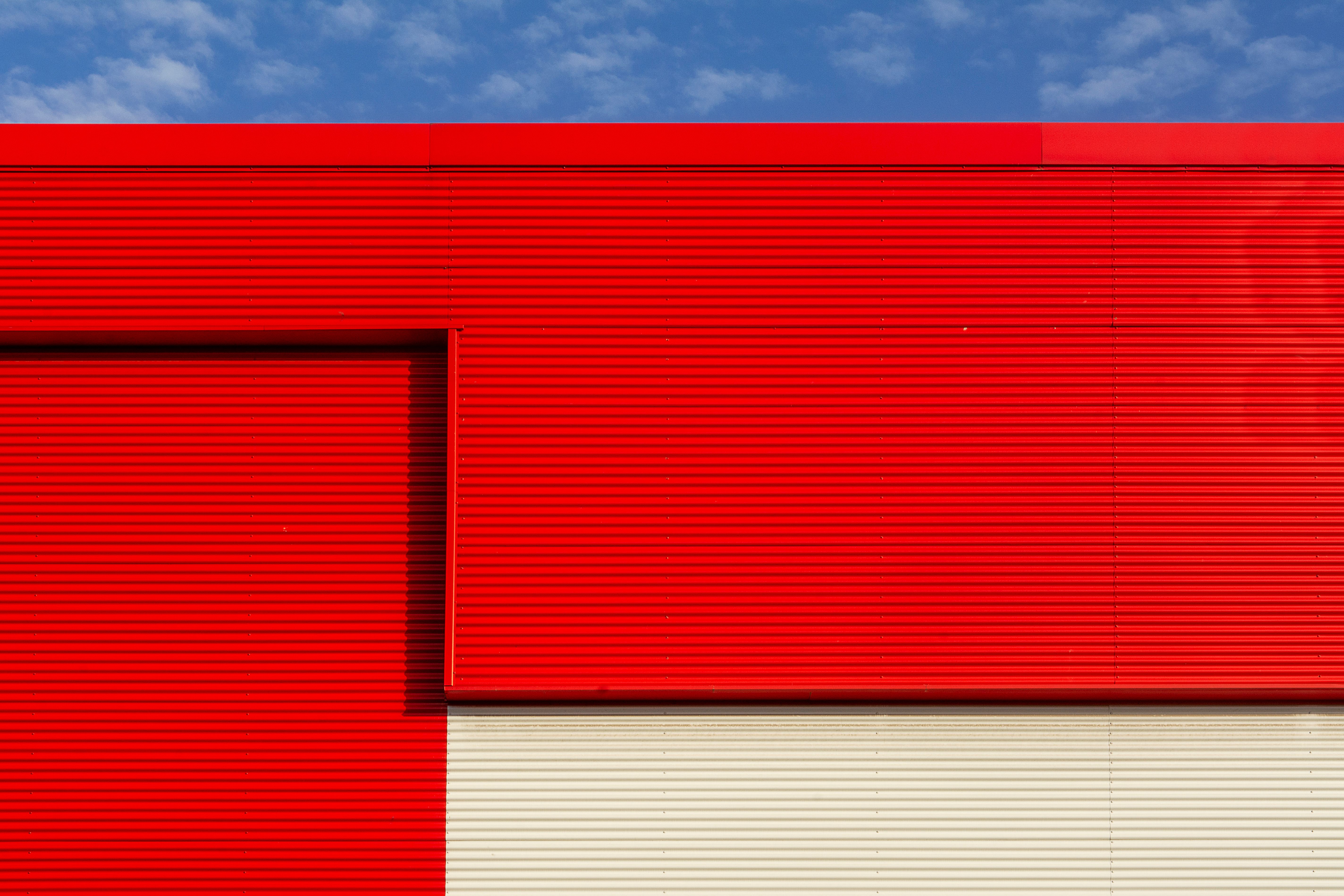 Bold Red and Cream Industrial Building Facade · Free Stock Photo
